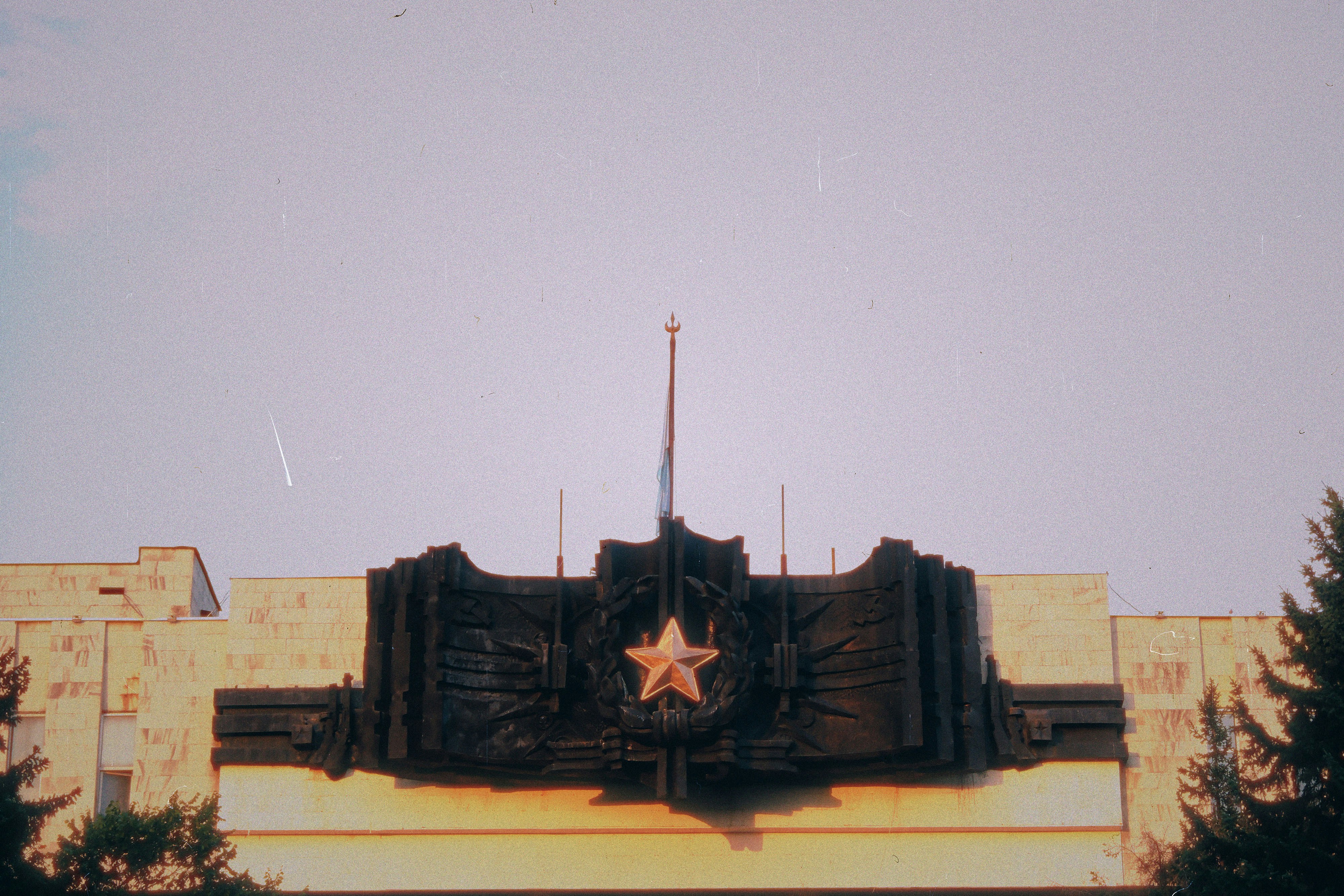 Star Above the Emblem: Monumental Crest in Late-Evening Light
