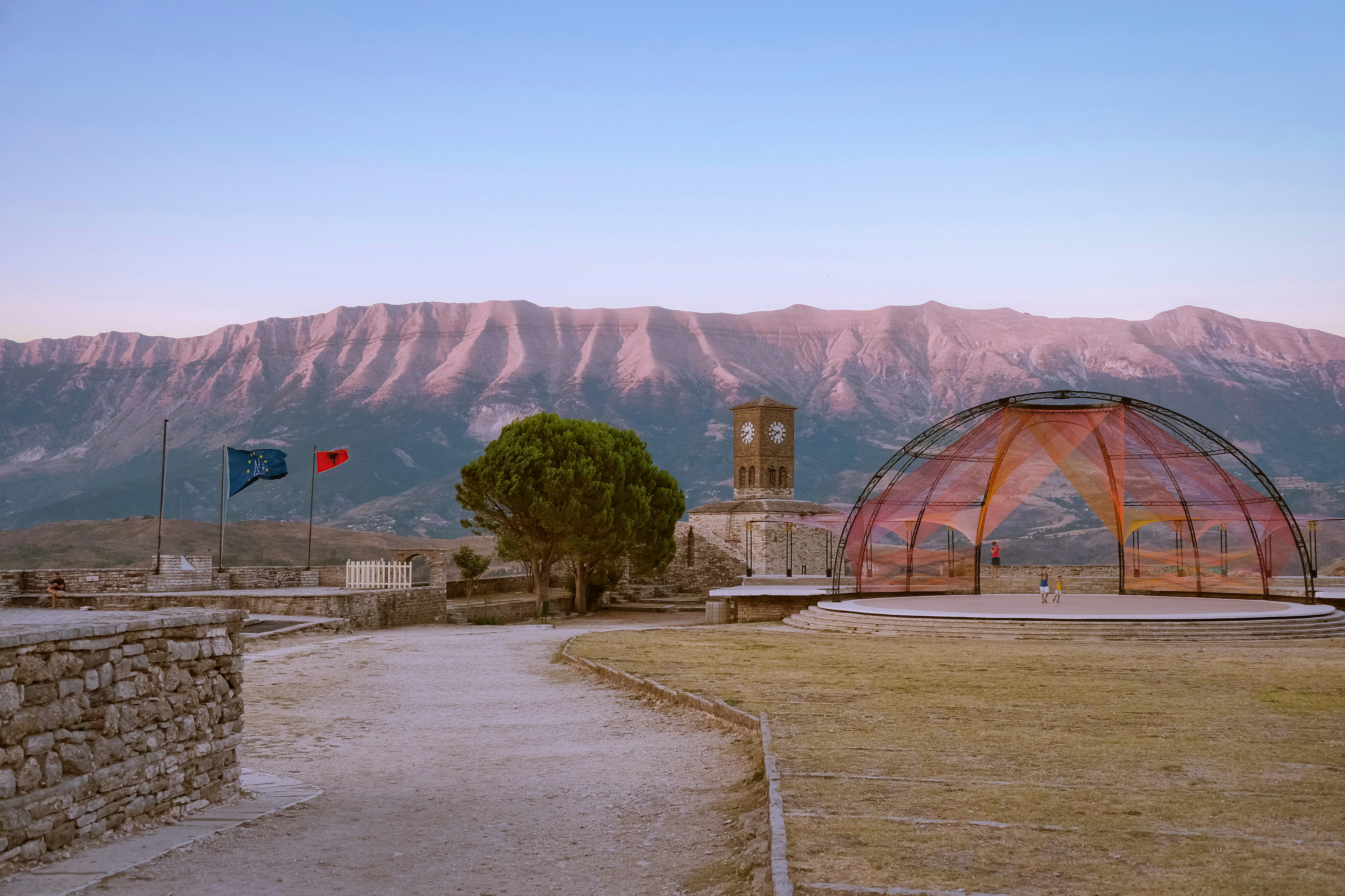 Courtyard at Distant Ridge: Flags, Clock Tower, and a Dome Shelter