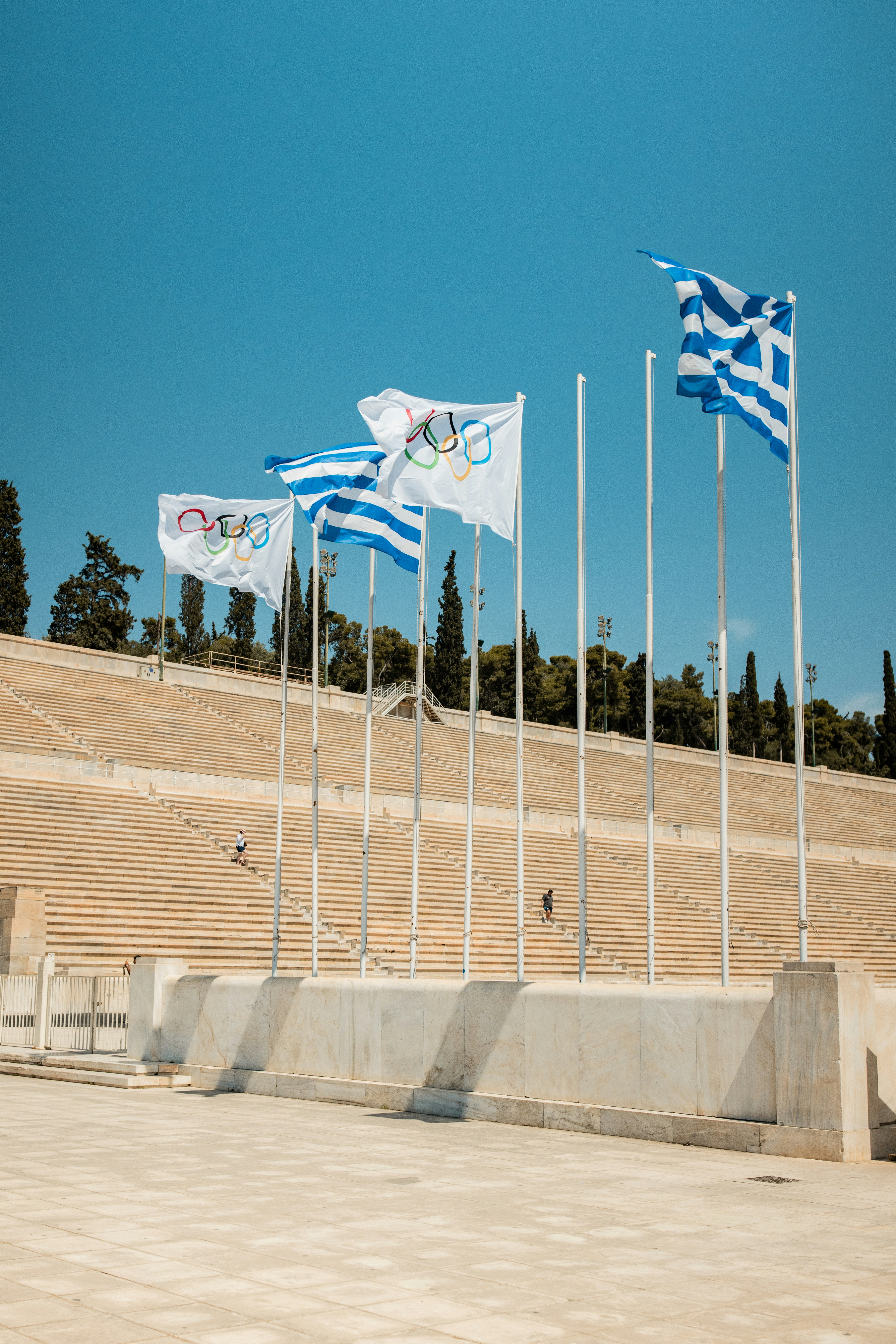 Flags of Motion: Olympic Emblems Flanked by Stone Steps