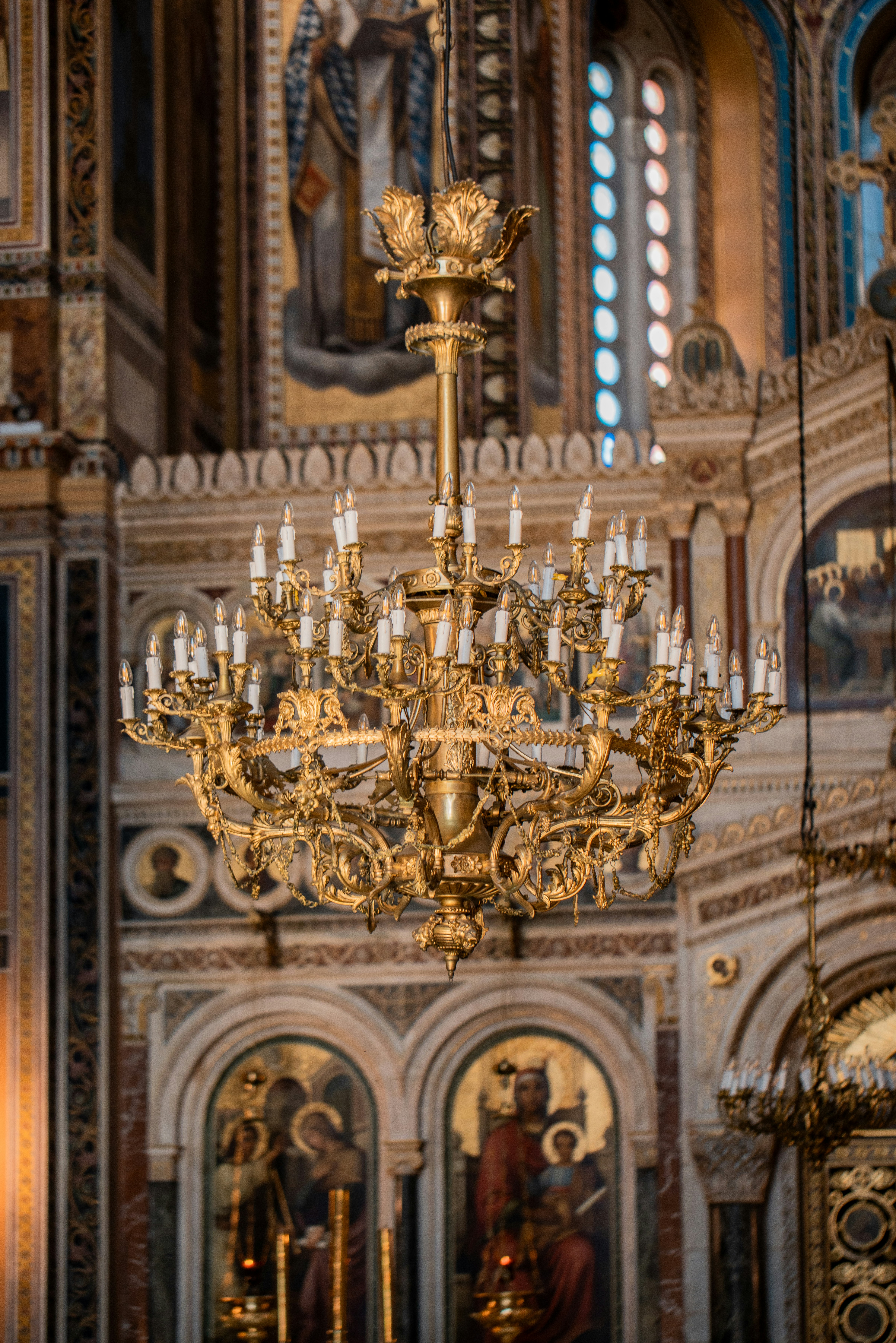 Golden chandelier glow under ornate church interiors