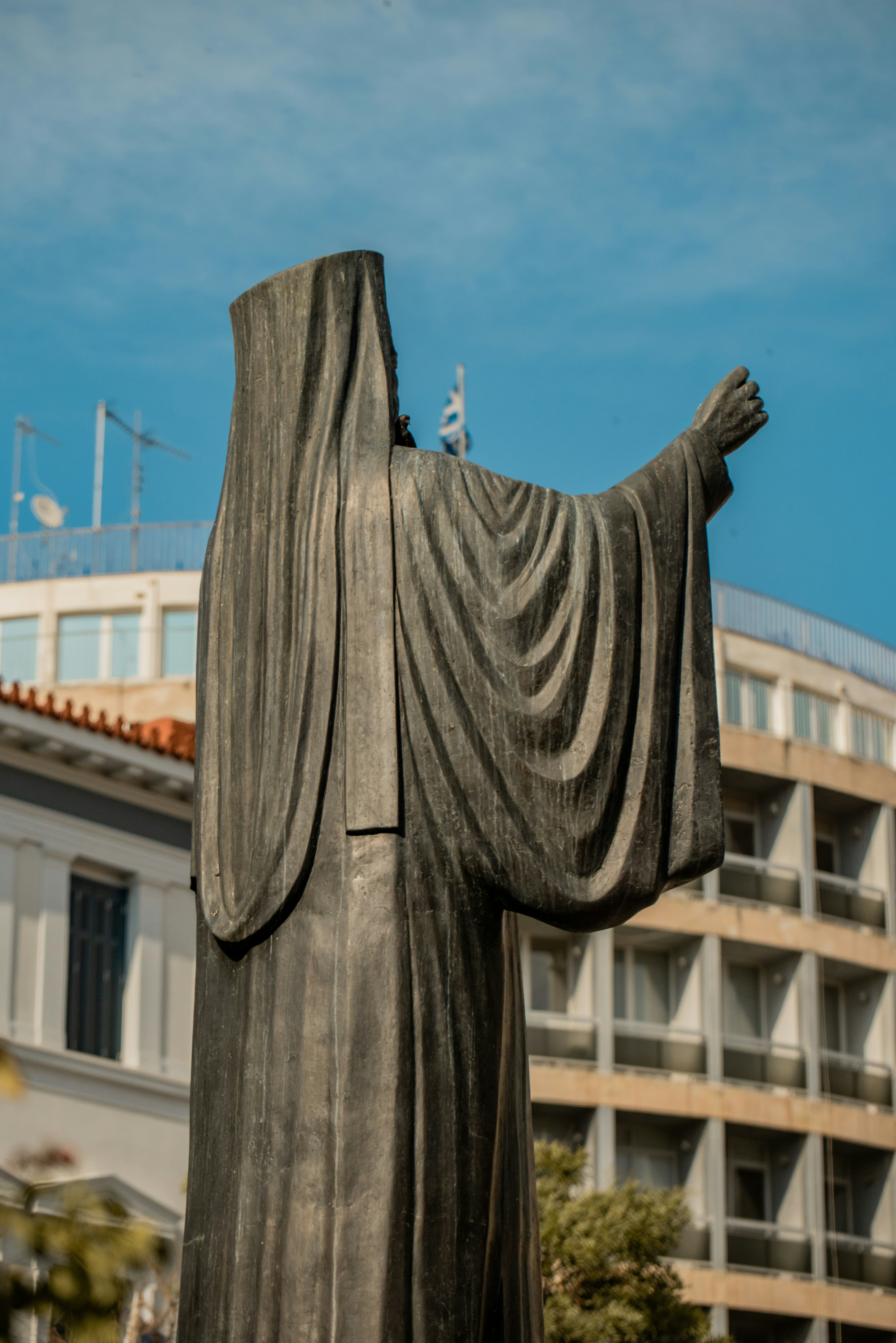 Veiled Gesture: A Bronze Cloak Reaching Toward the Sky