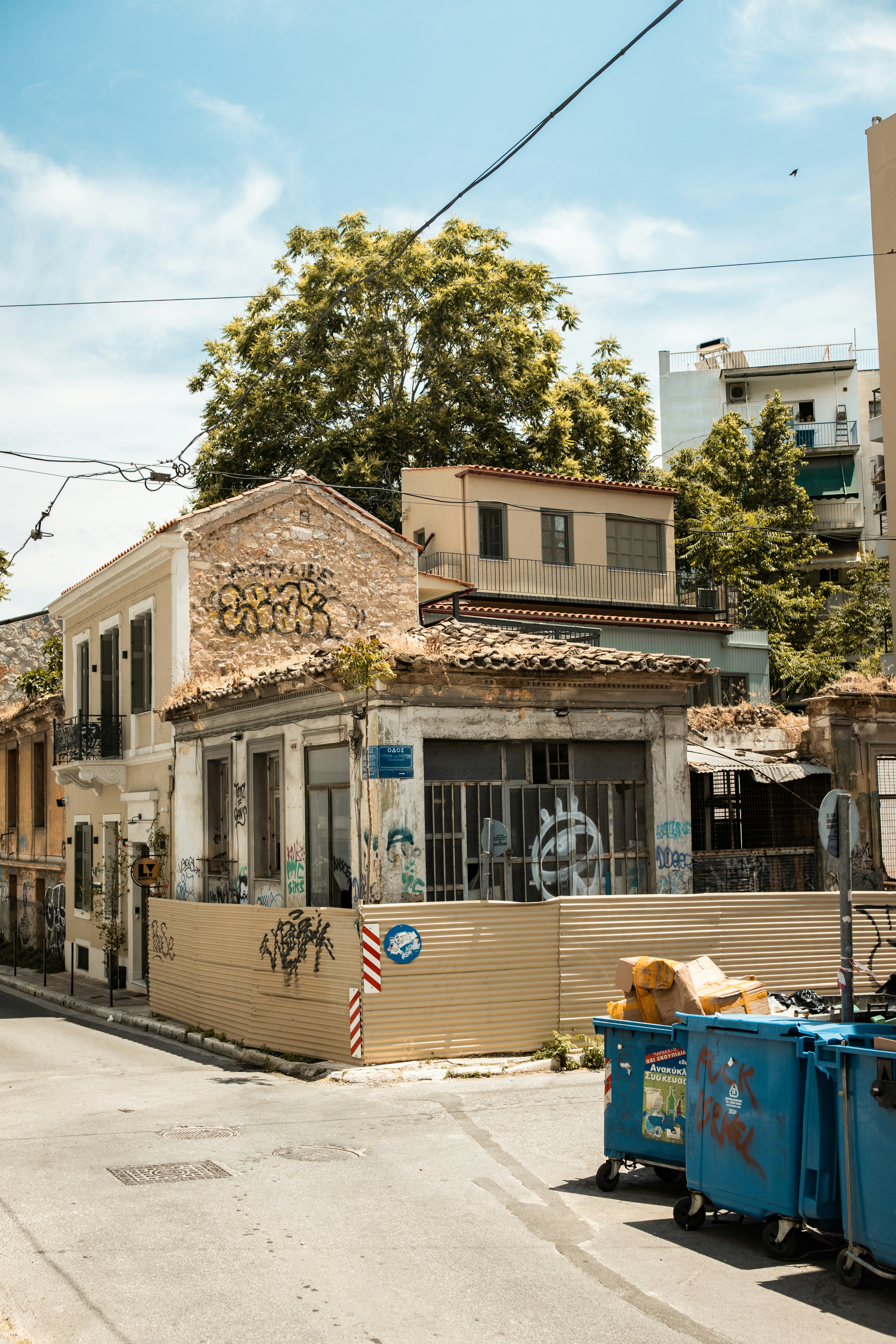 Sunlit Corner Shop with Graffiti and Urban Debris