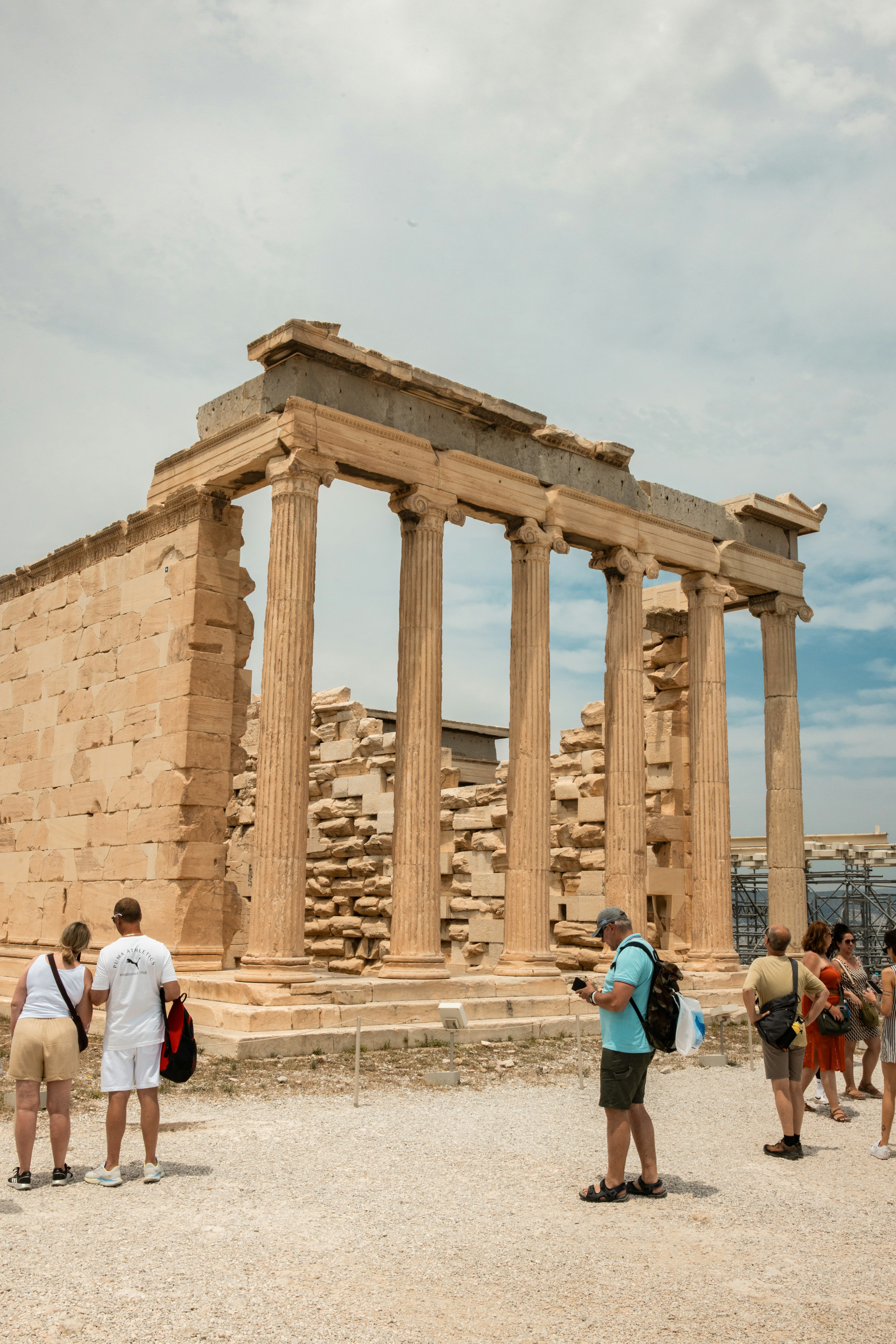 Ancient Temple Ruins Framed by Visitors on a Sunlit Day