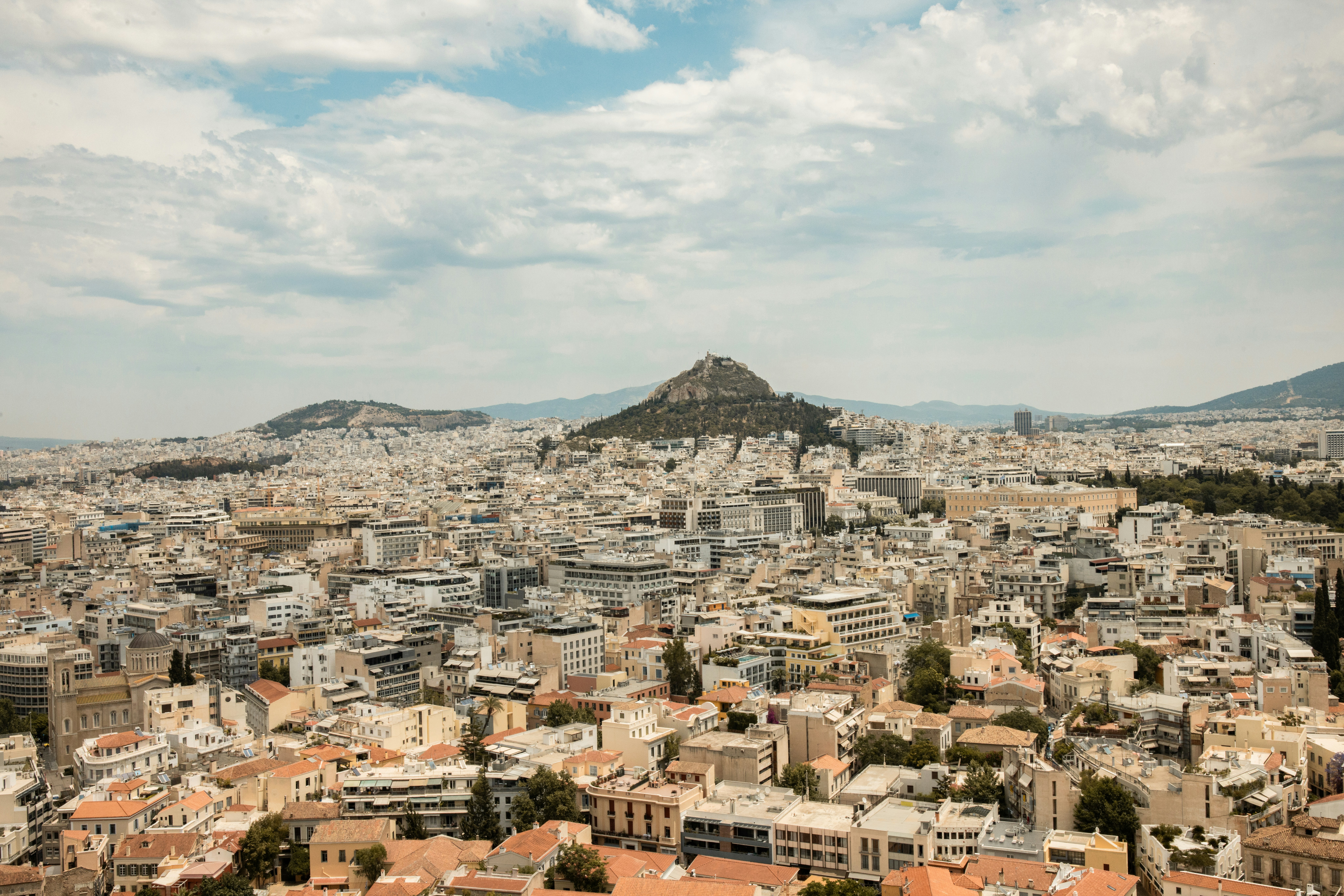 Hilltop cityscape beneath a drifting sea of clouds