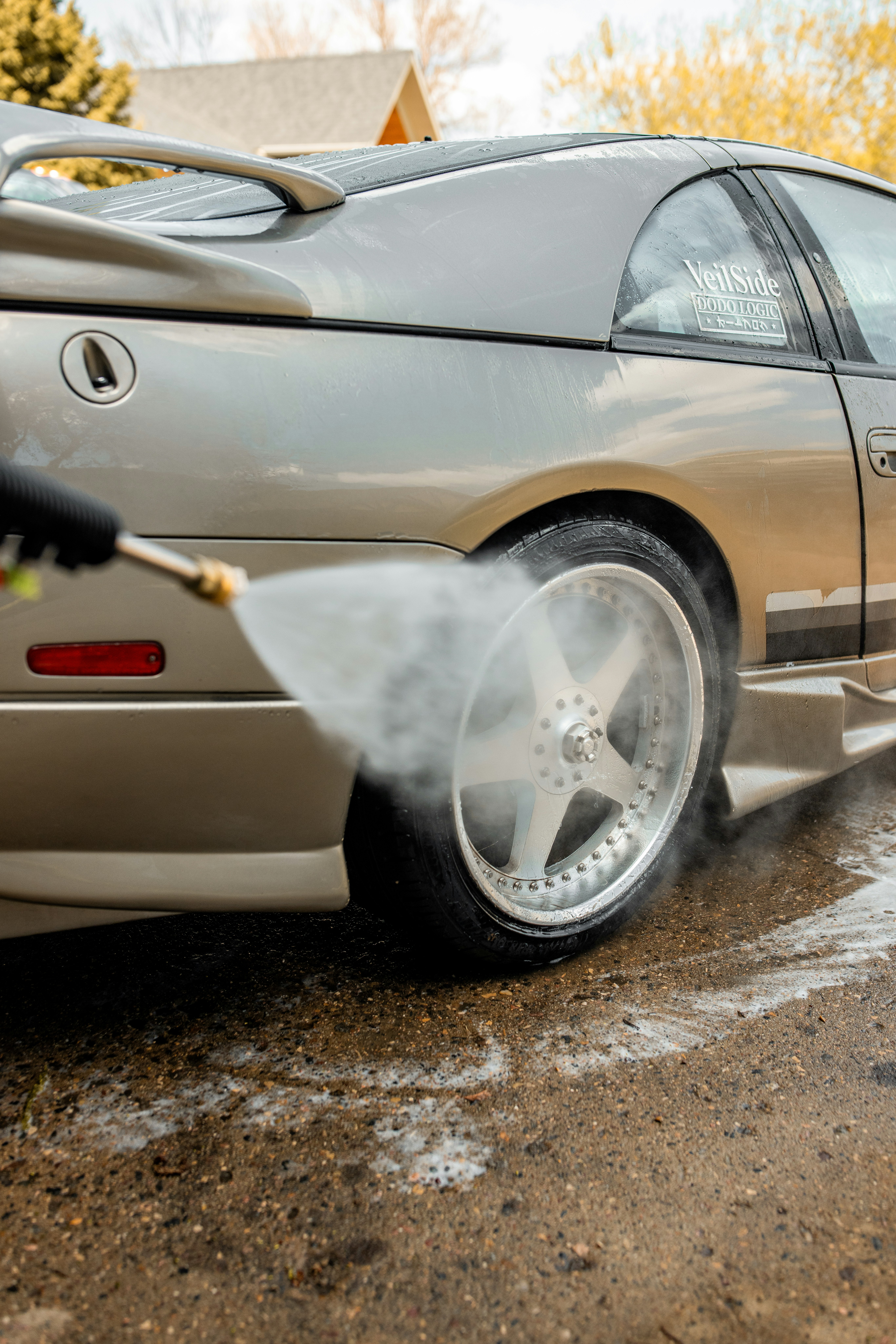 Shifting Spotlight: Car Covered in Steam During a Wet-Warm Wash