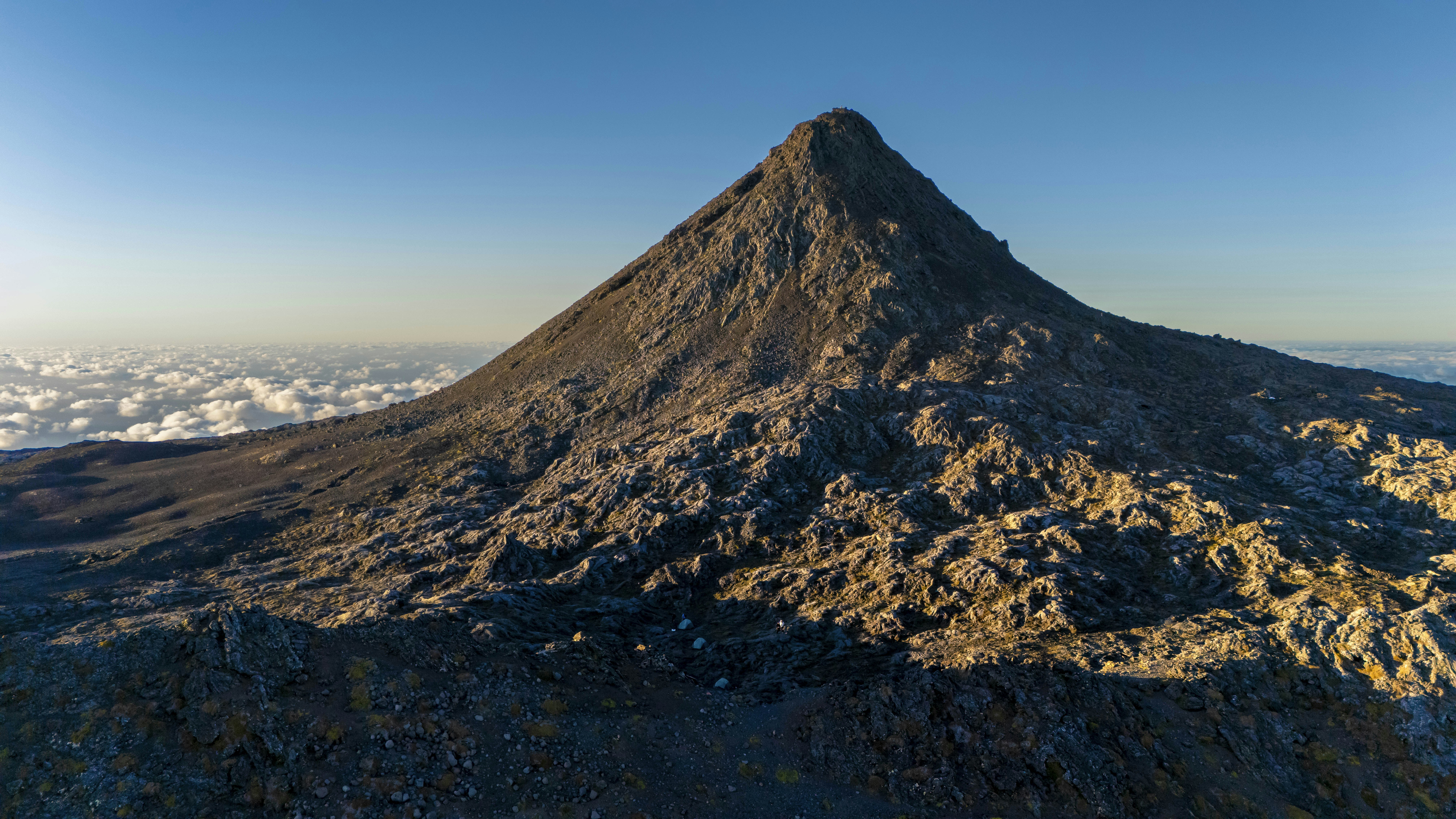 Cone of Clarity: A Lone Volcano Rises Above a Sea of Clouds