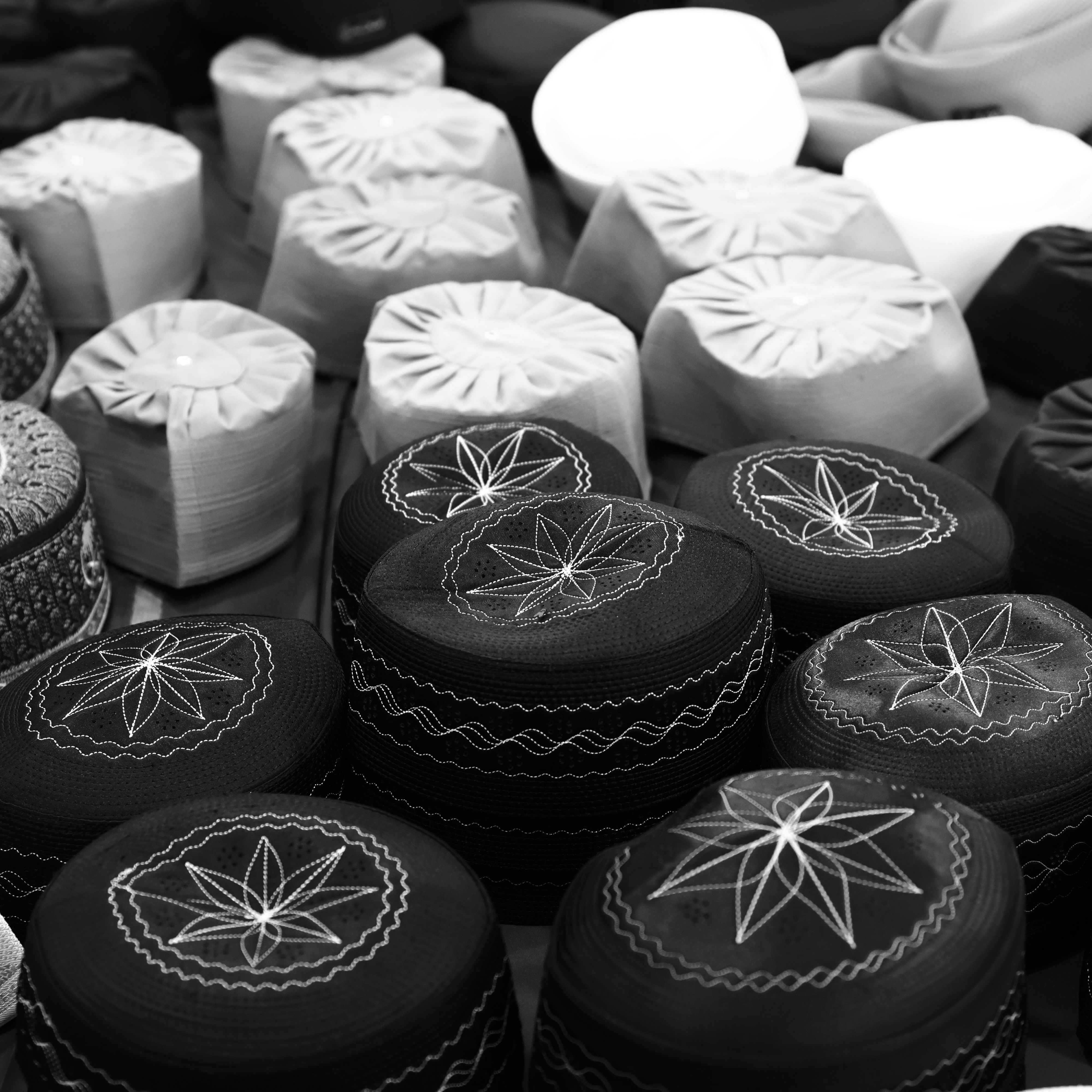 Embossed Cannabis Motifs: A Close-Up on Round Charms and Carved Whorls