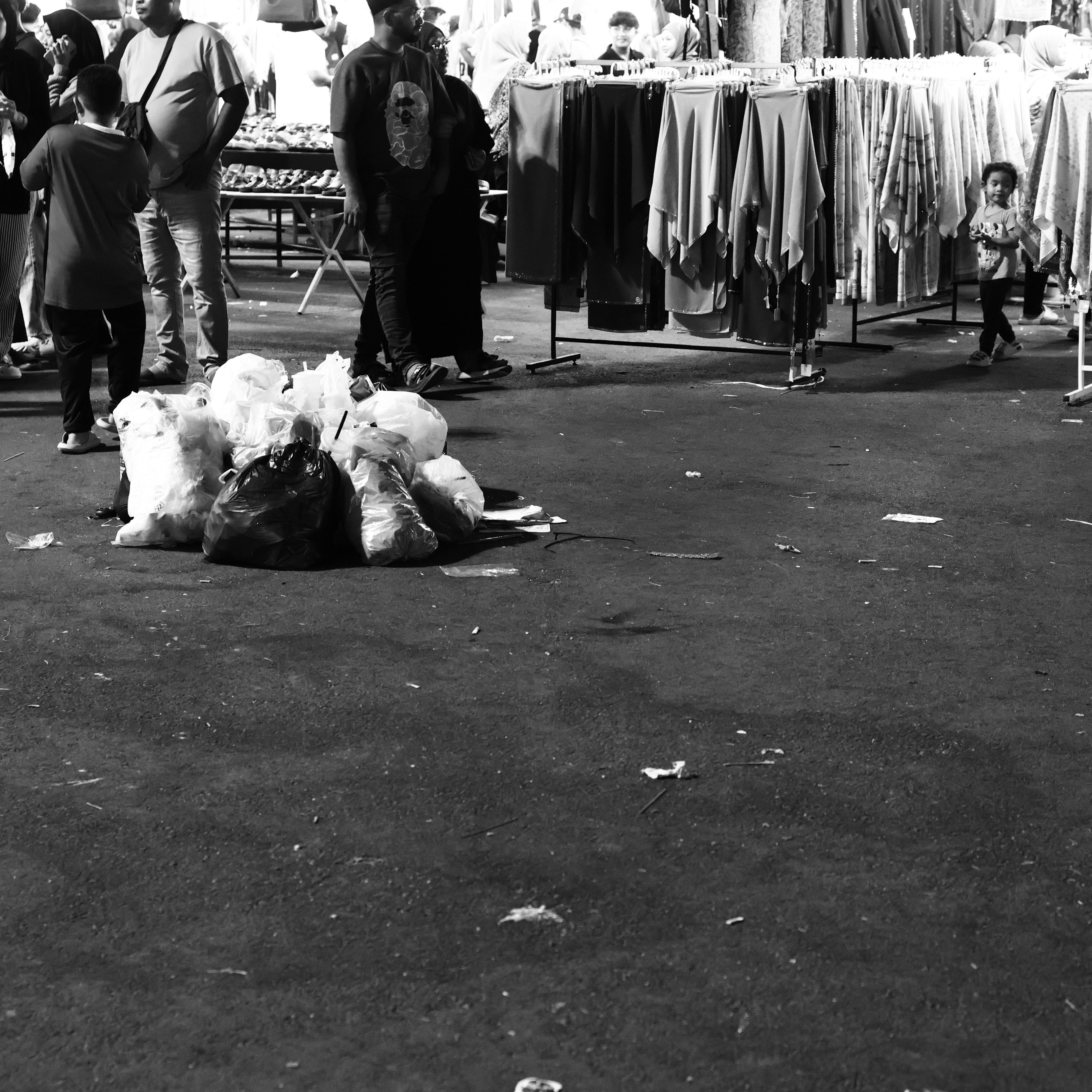 Market Shadows: A Tangle of Garments and Garbage Under Neon Grids