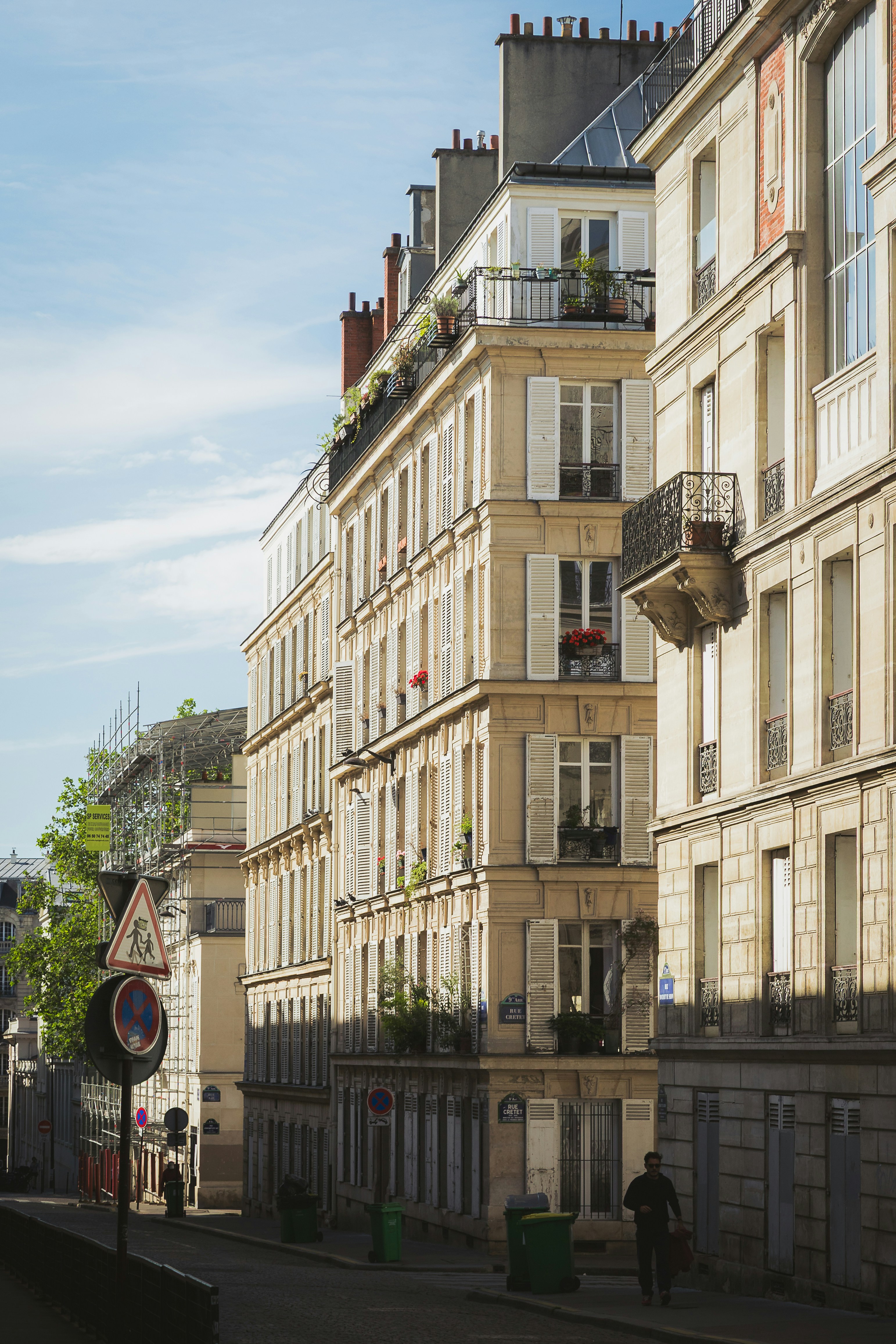 Sunlit Parisian Facades: A Quiet Street Nestled Between Tall Windows