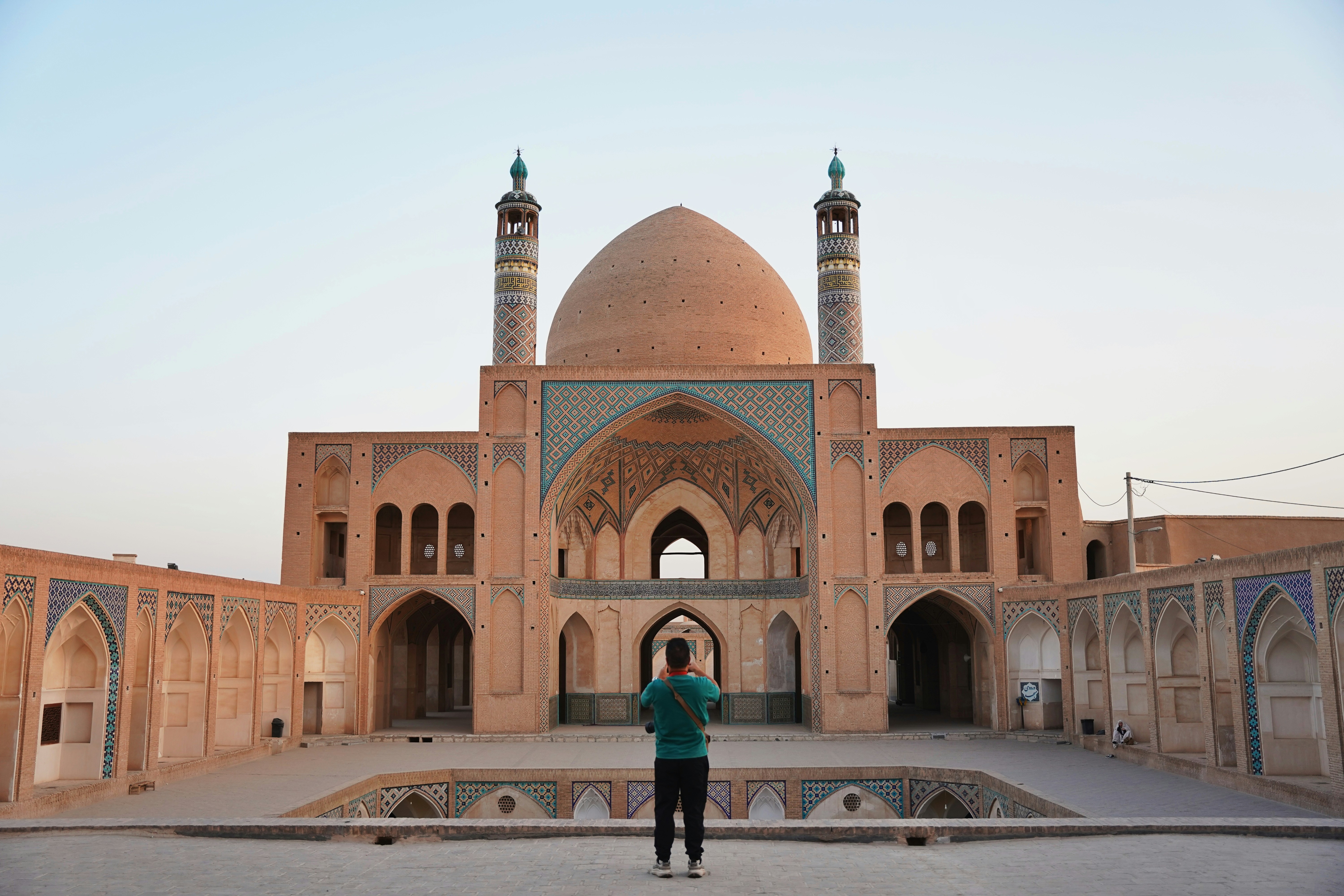 Traveler at the Gate: Symmetry and Spires in a Desert Courtyard