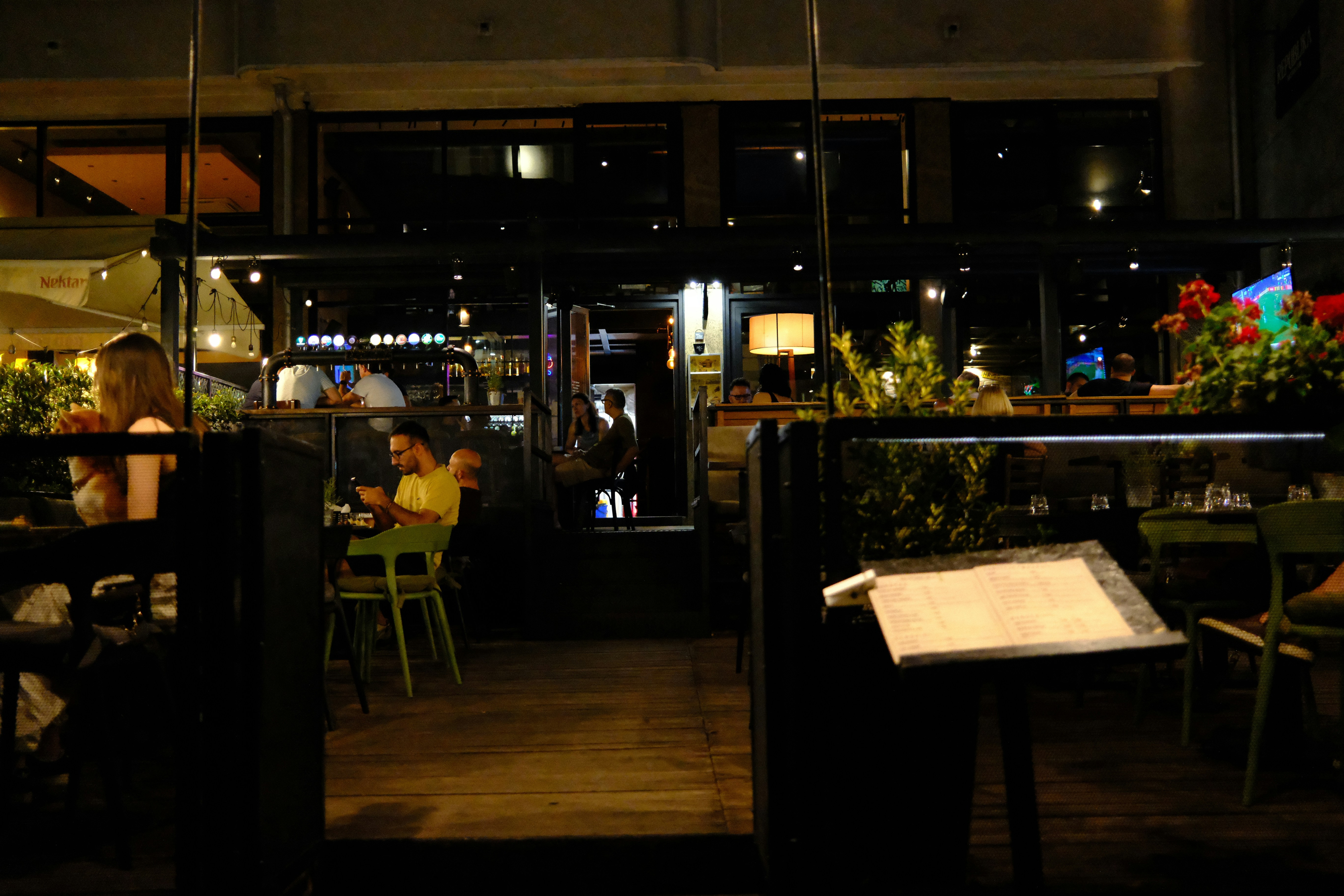 Night Café Quiet Moments: patrons and menu lanterns in warm glow