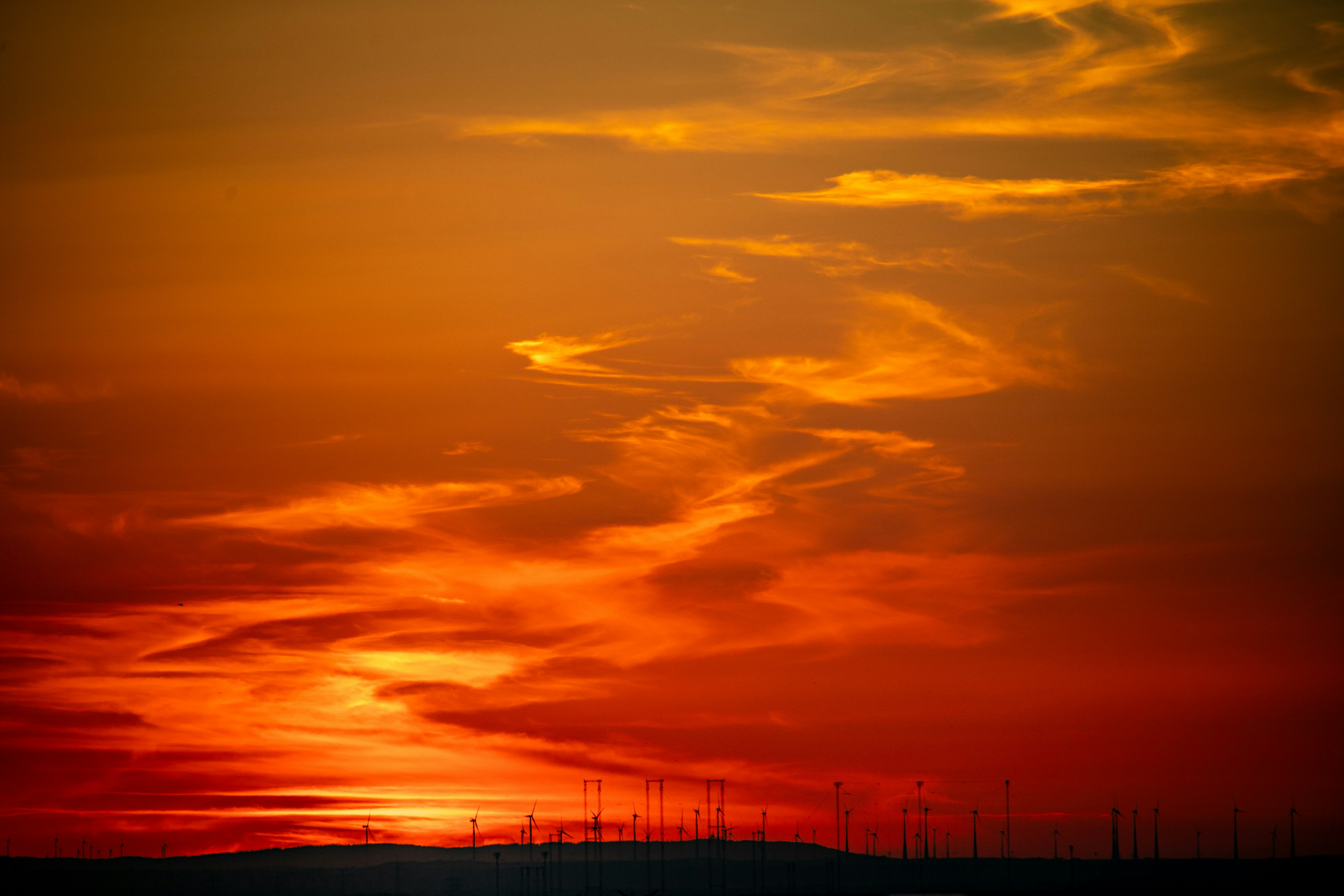Glowing Horizon: A Fiery Dusk over Silent Antenna Silhouettes