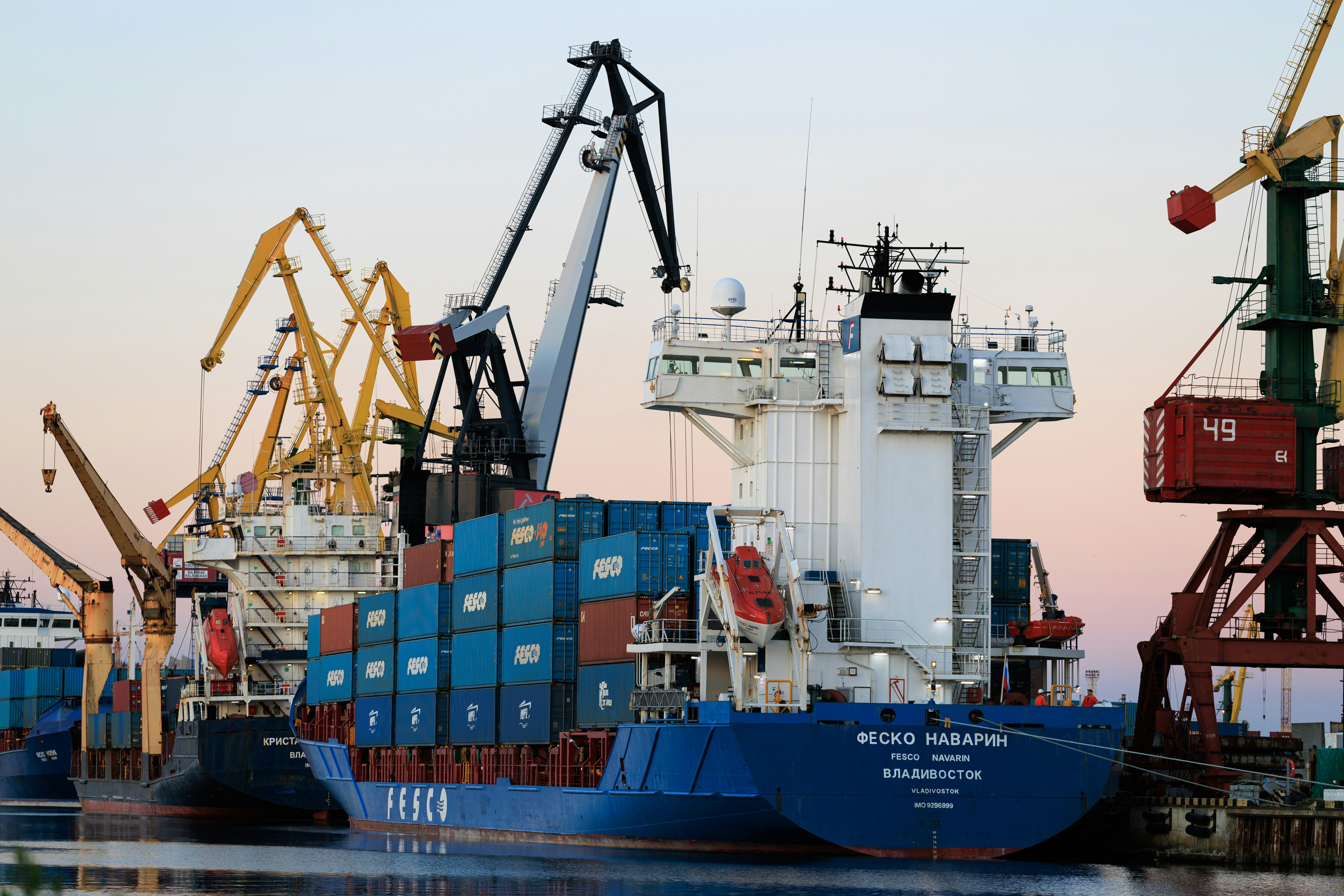 Container Vessel at Sunset: Industrial Ballet of Cranes and Hulls