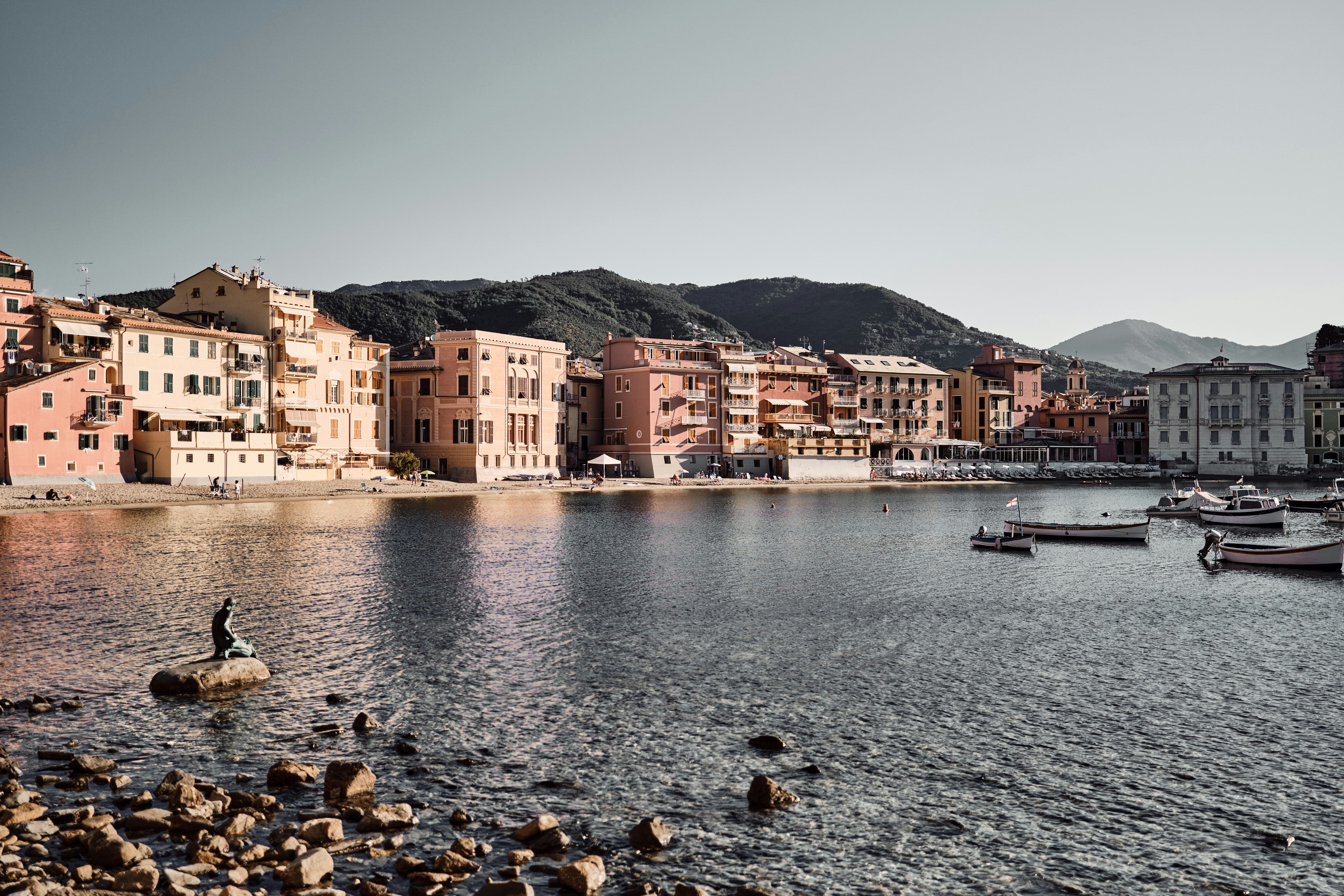Harbor Terrace: Sunlit Buildings Reflect on Calm Sicilian Waters