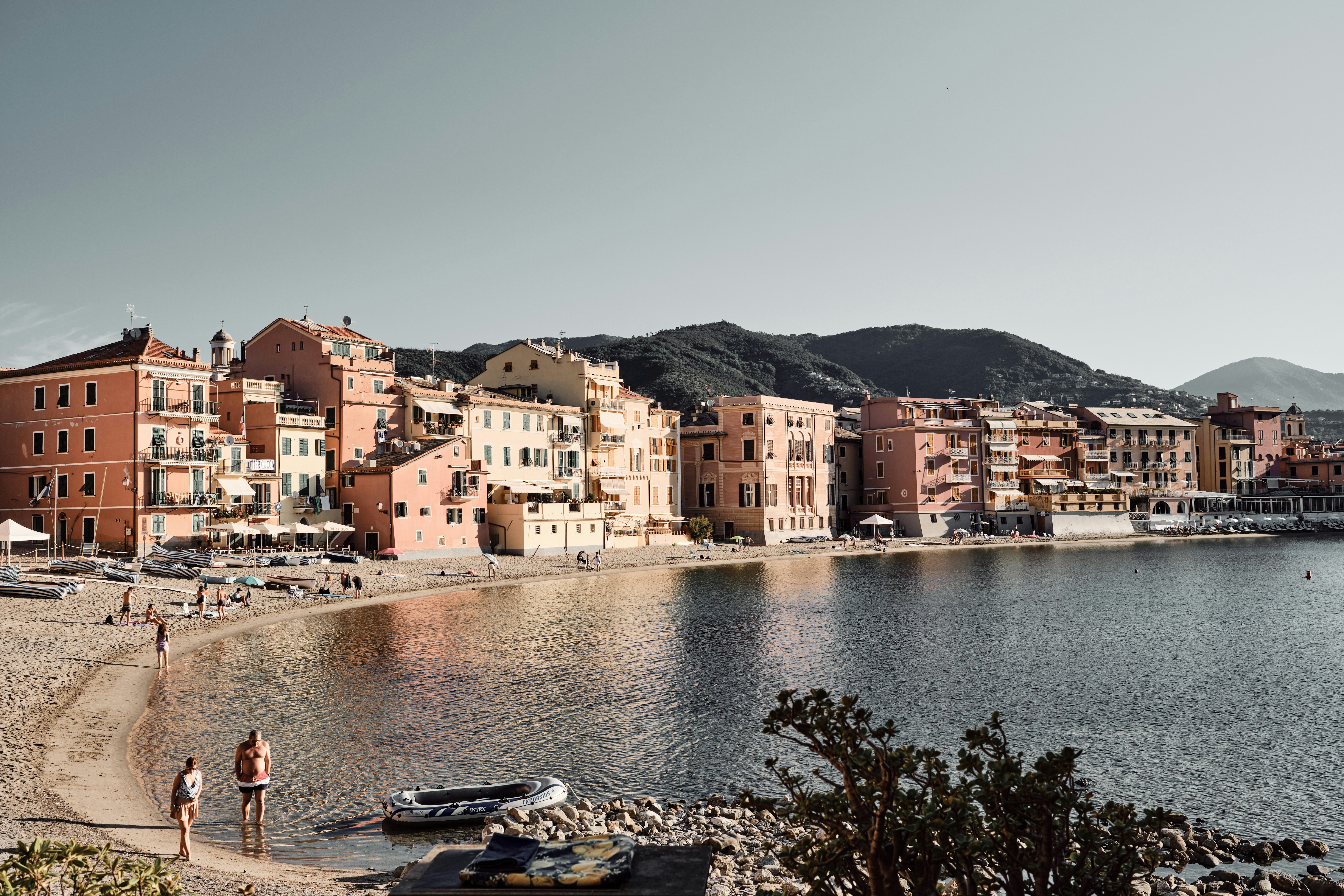 Pastel Harbor: Coastal Buildings Embrace Calm Waters