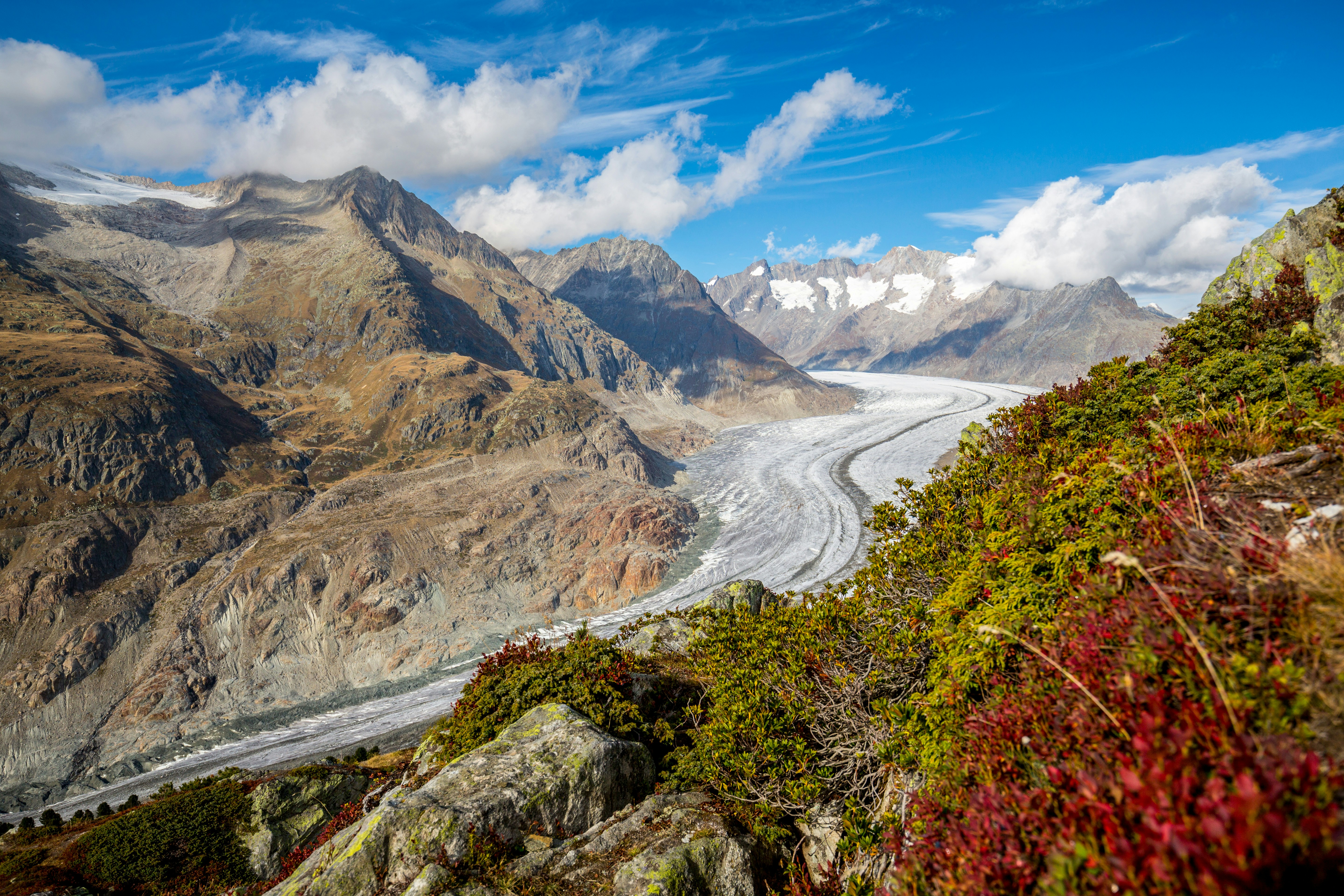 Glacial River bends through a basin beneath jagged alpine peaks
