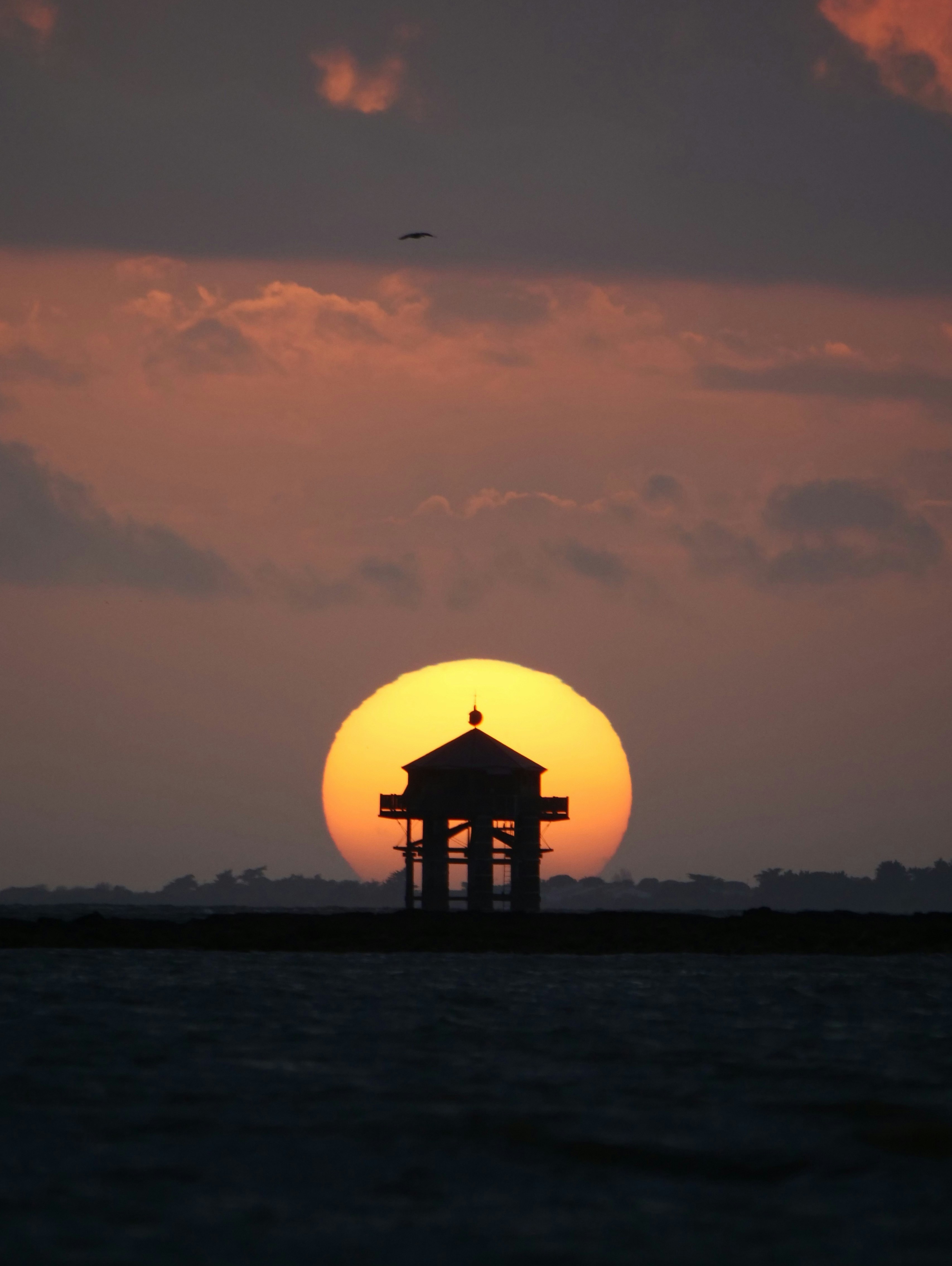 Sunset Silhouette Over a Stilted Pavilion