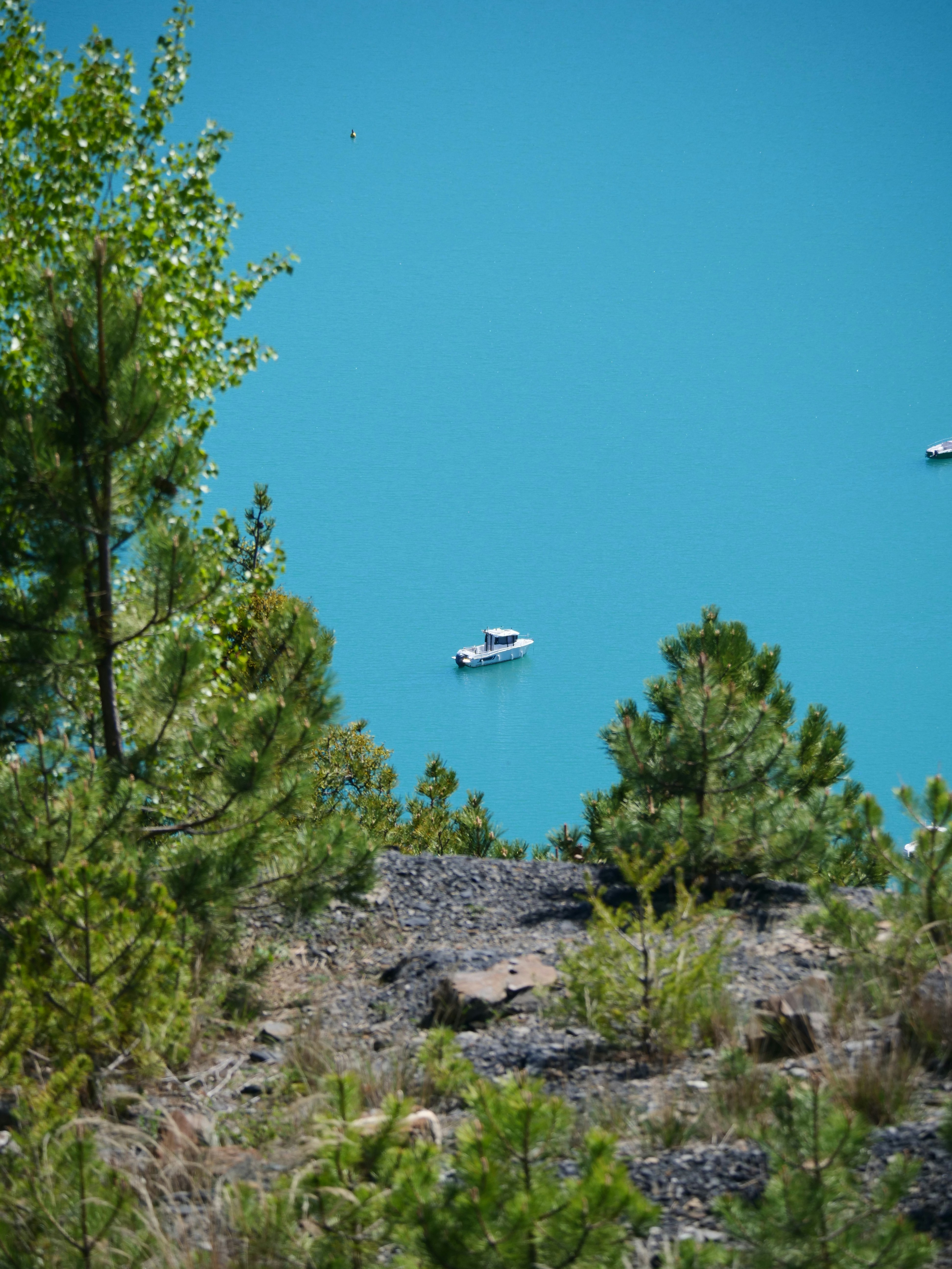 Blue Oasis: Small Boat Anchored in Quiet Alpine Water
