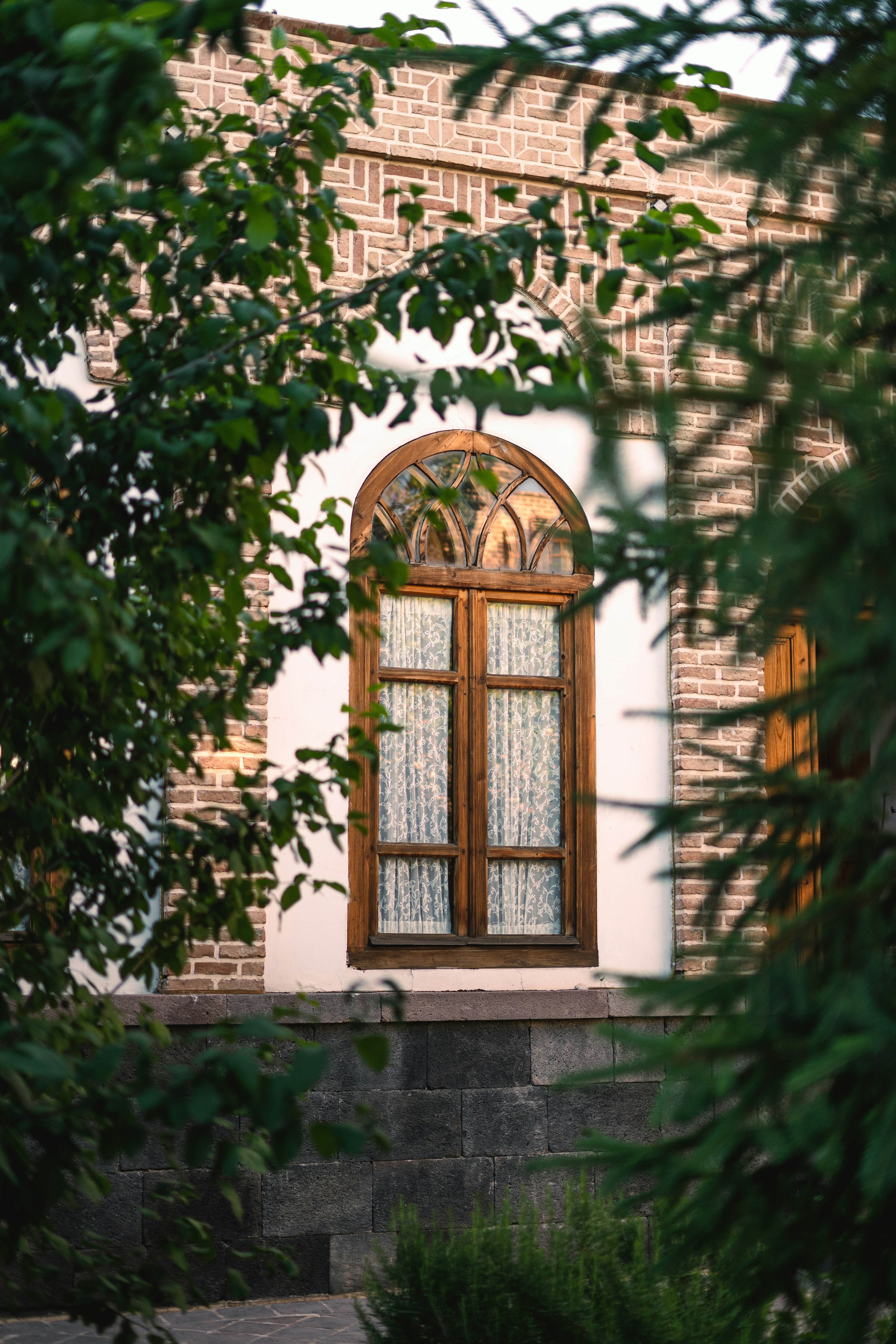 Hidden Arch Window Amid Garden Veil