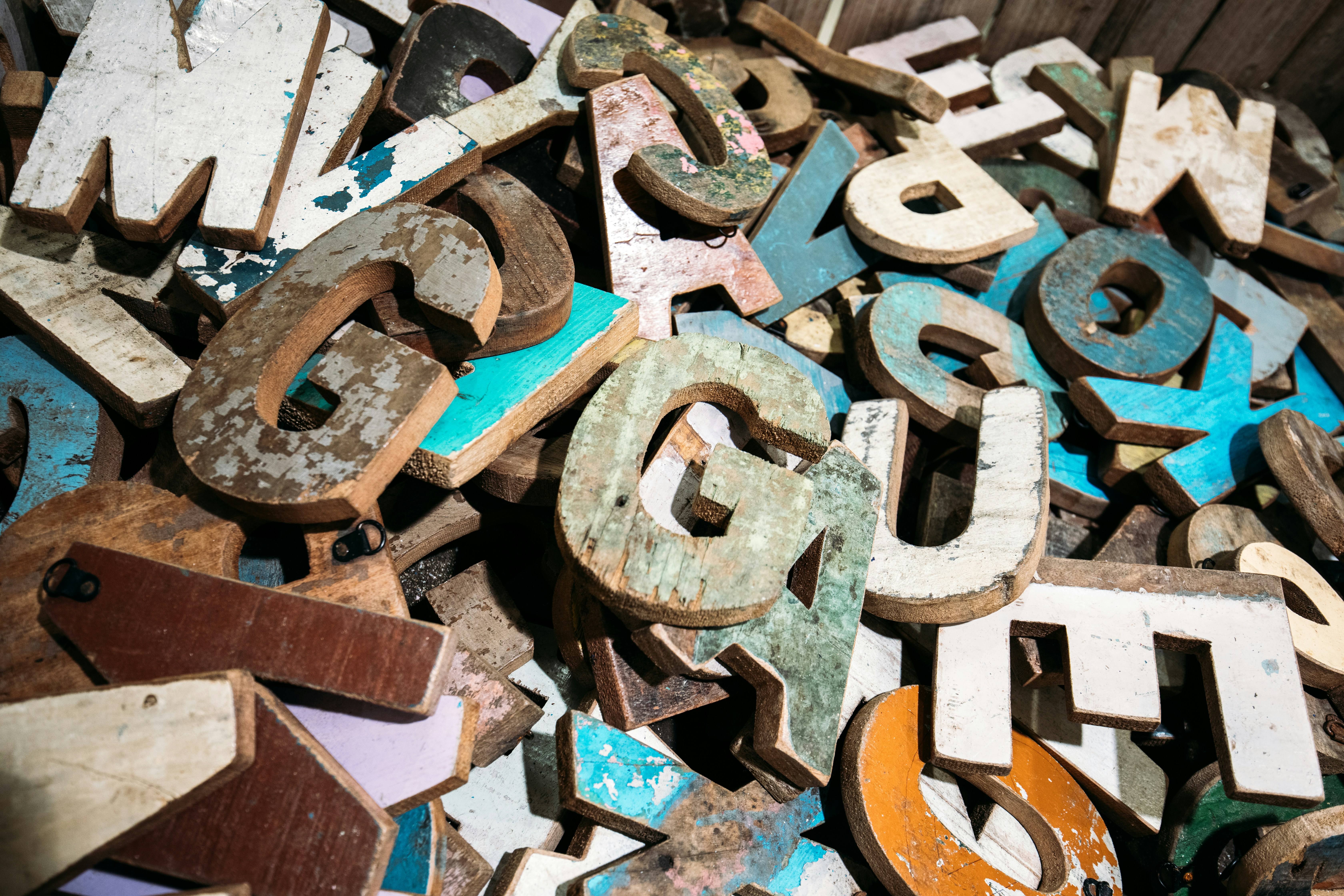 Chaotic Alphabet Waltz: Weathered Letters in a Colorful Stack