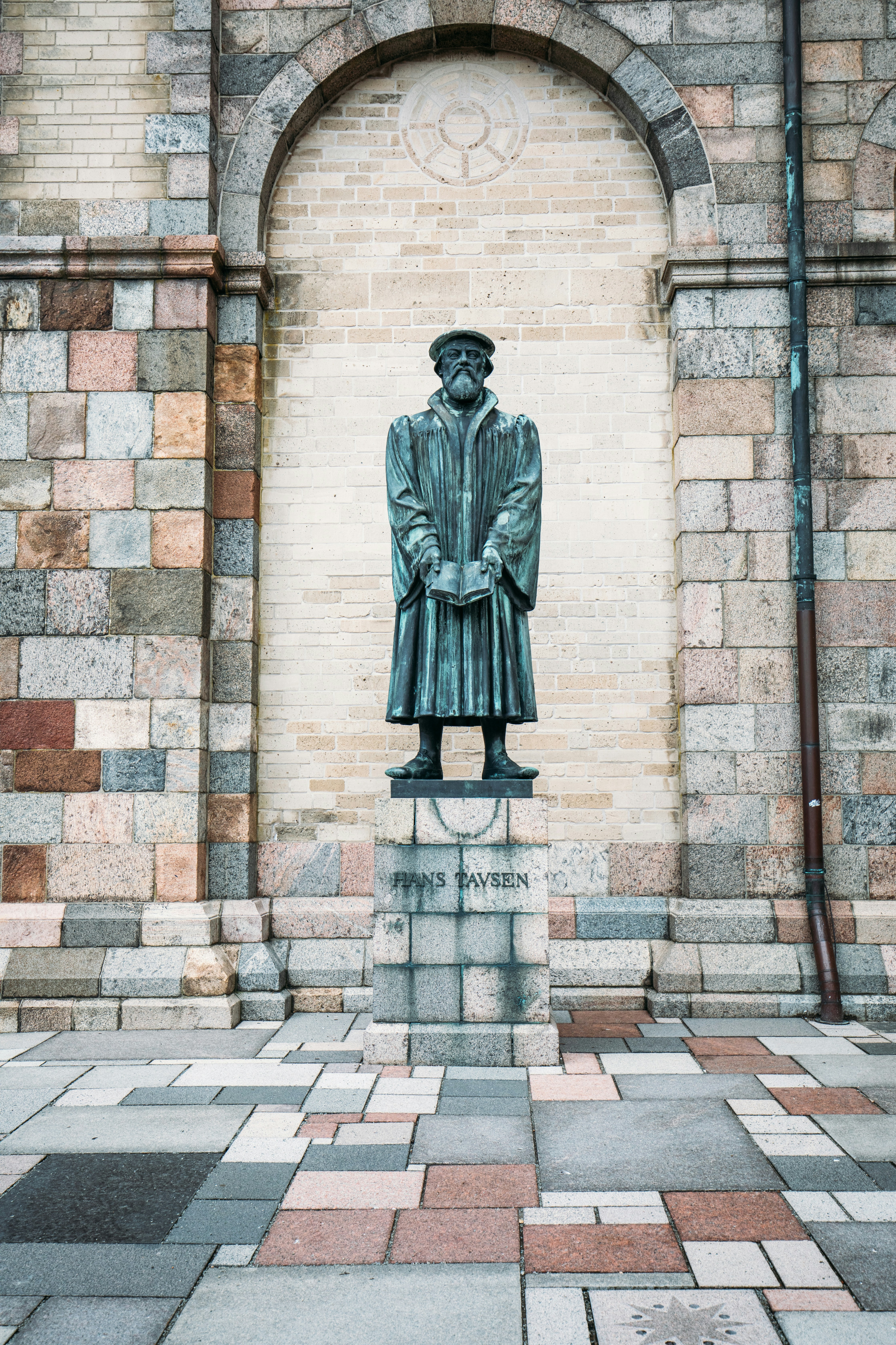 Statue of Jens Hansen Beneath Arched Brickwork
