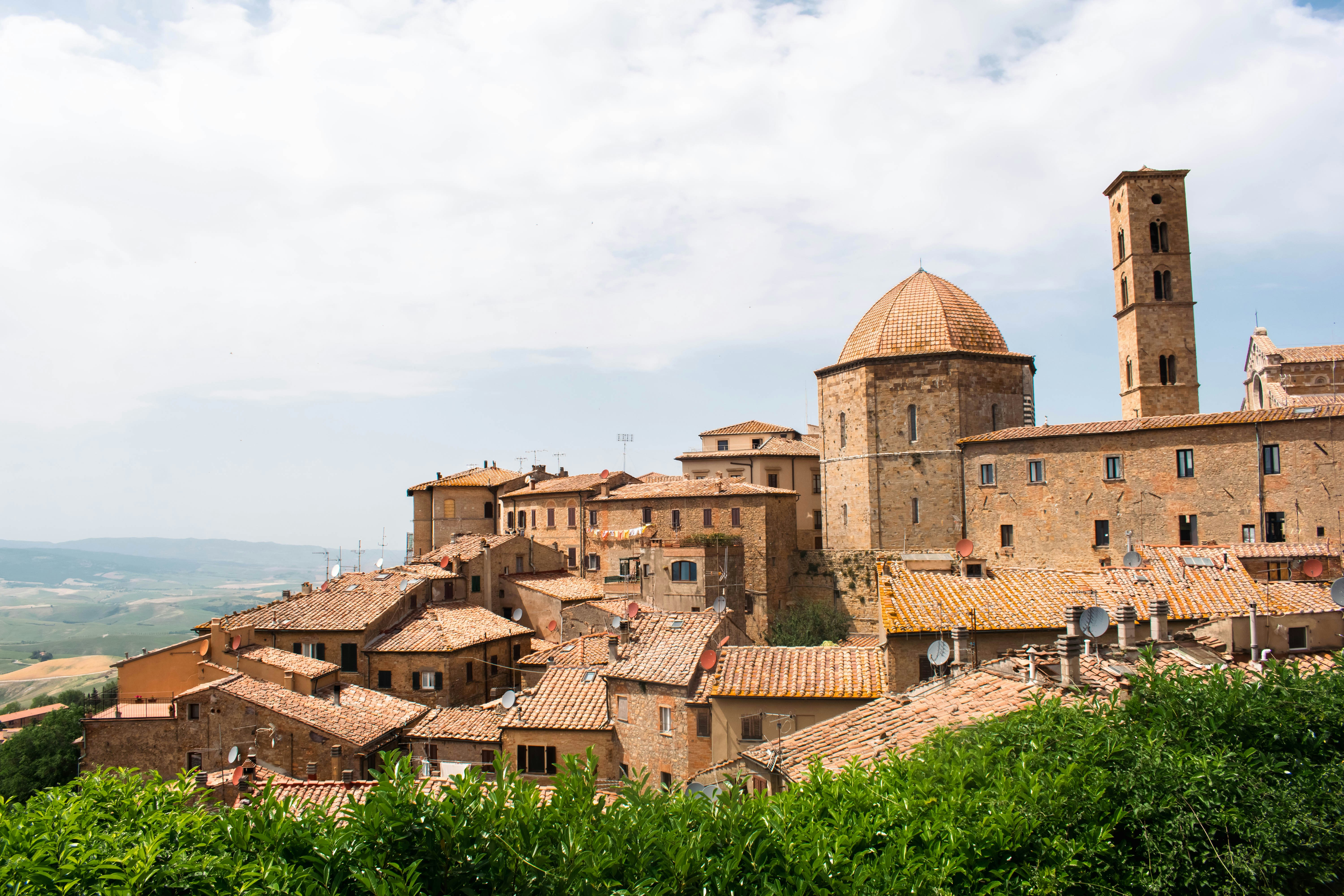 Terracotta rooftops and a bell-tower silhouette