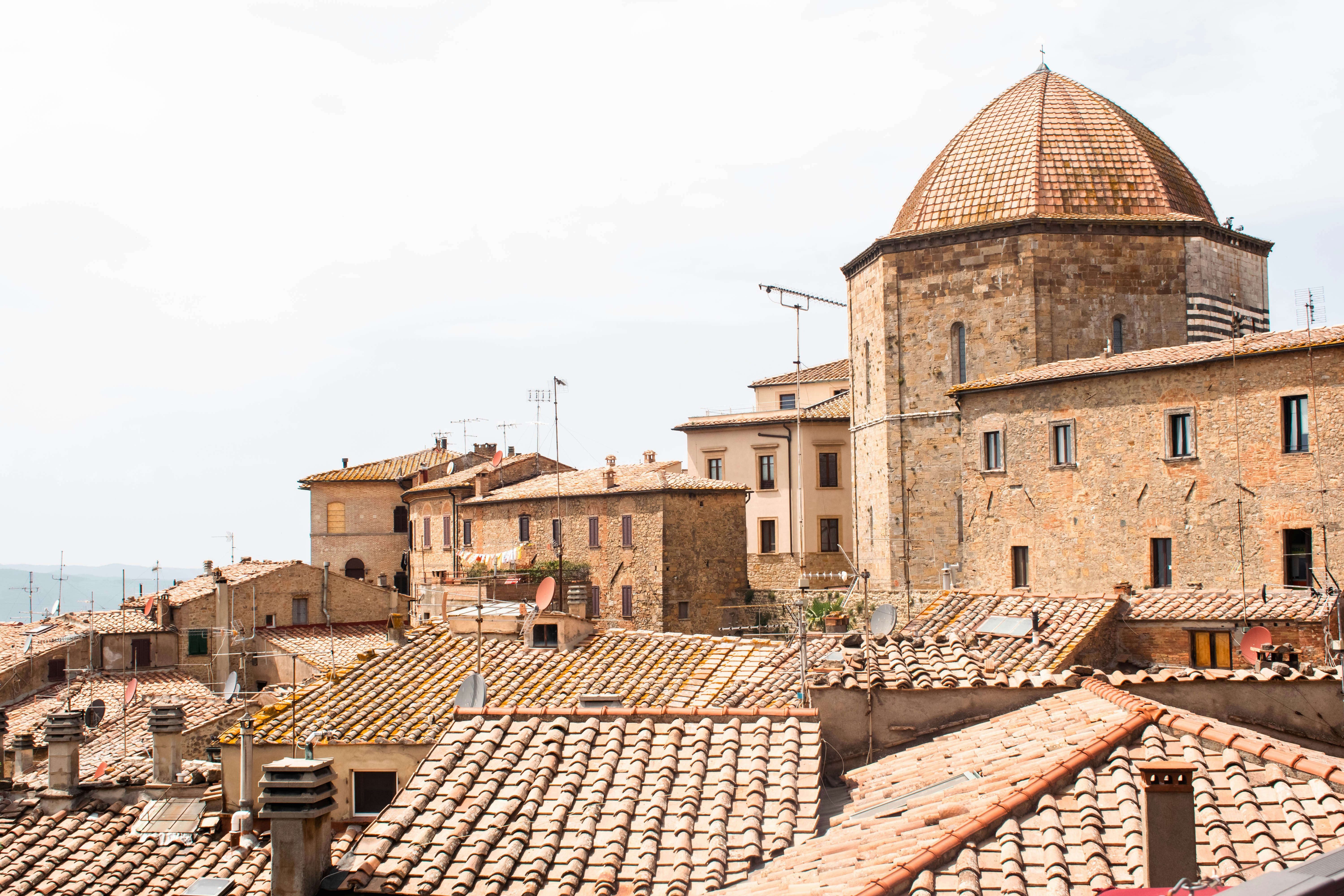 Terracotta Rooftops and a Dome Above a Coastal Italian Town