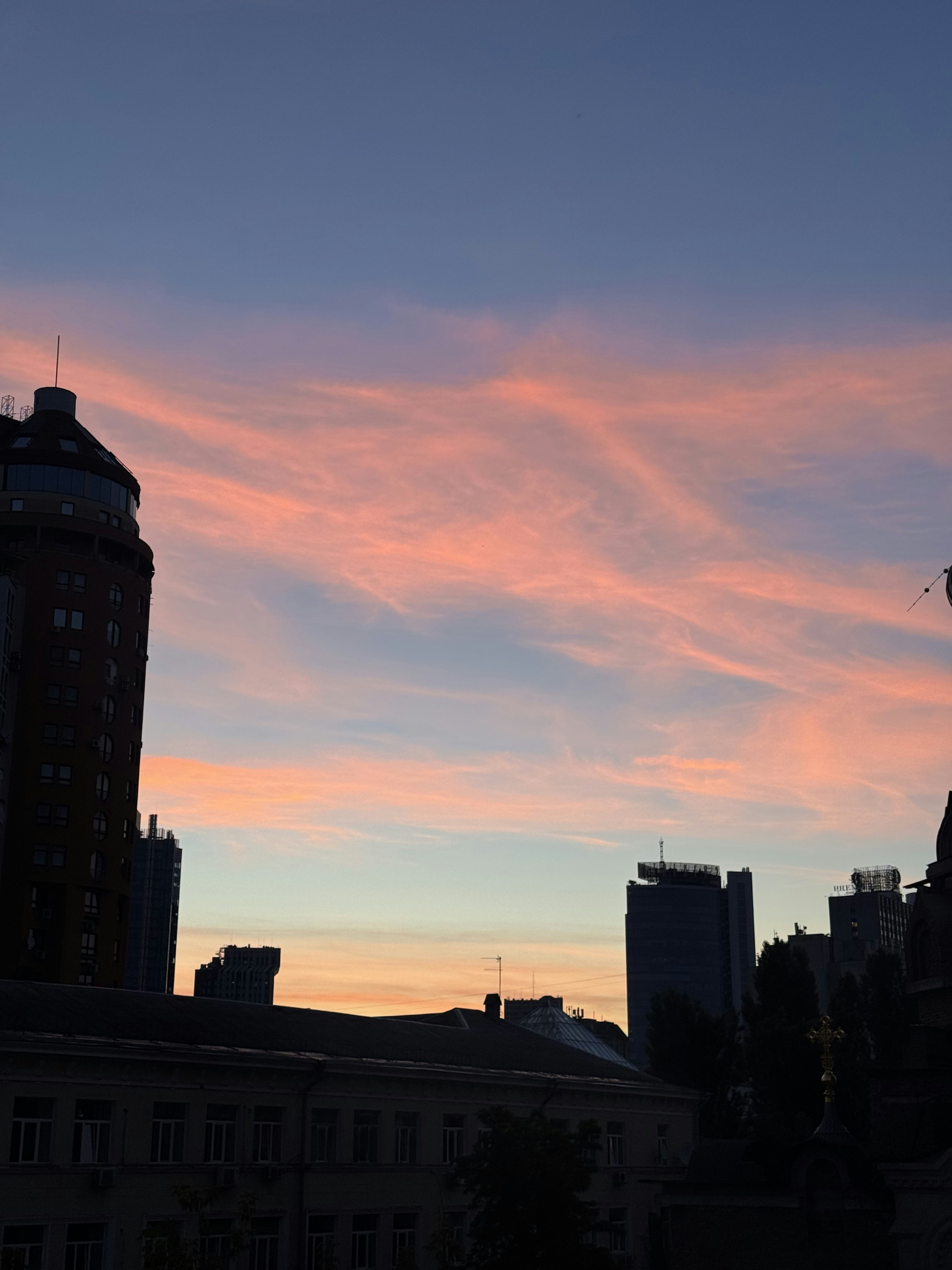 Sunset Over the City: Silhouettes Against a Peach Sky