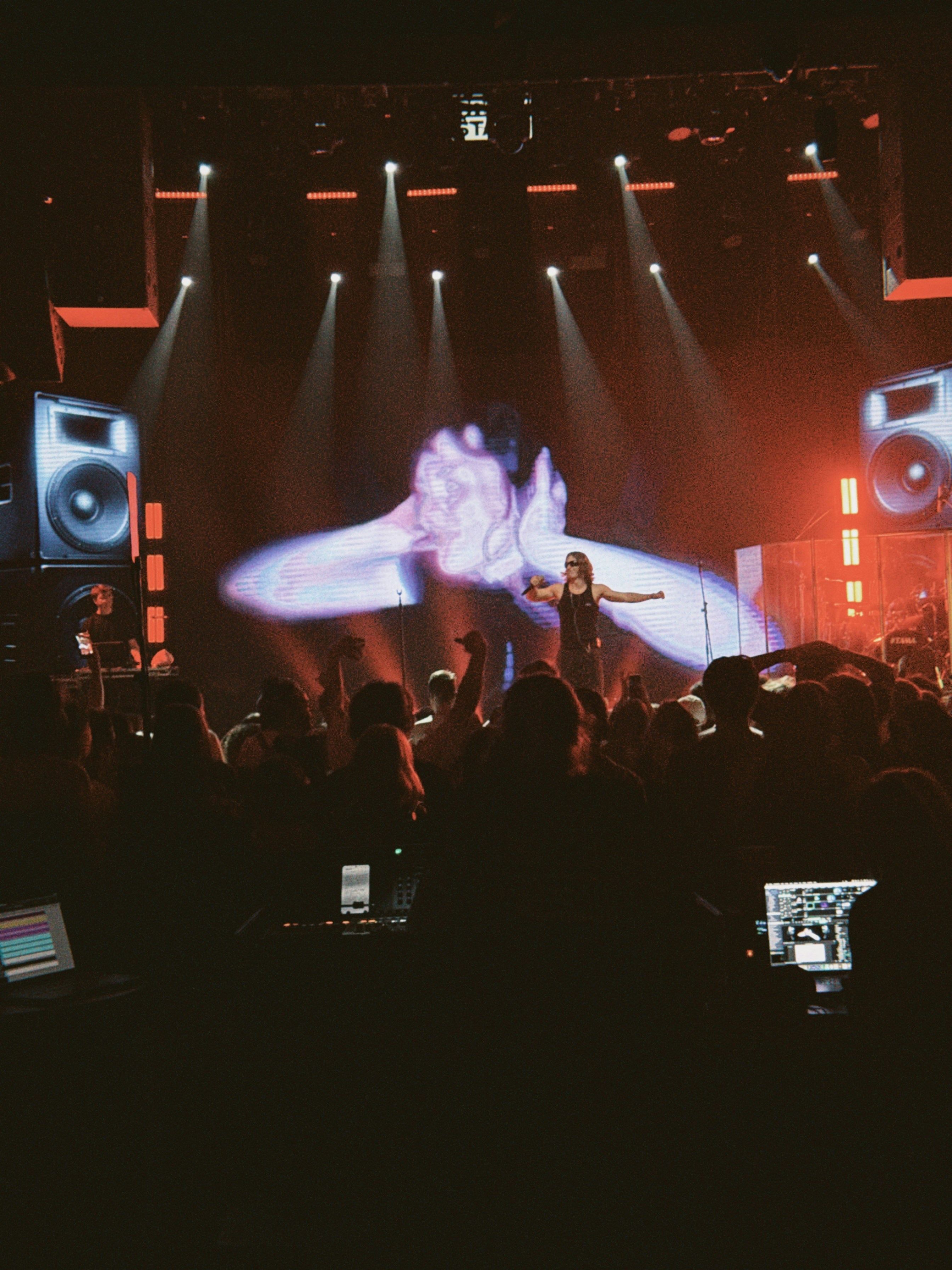 Midnight Stage: Singer in Red Lights Under a Pulsing Skyline