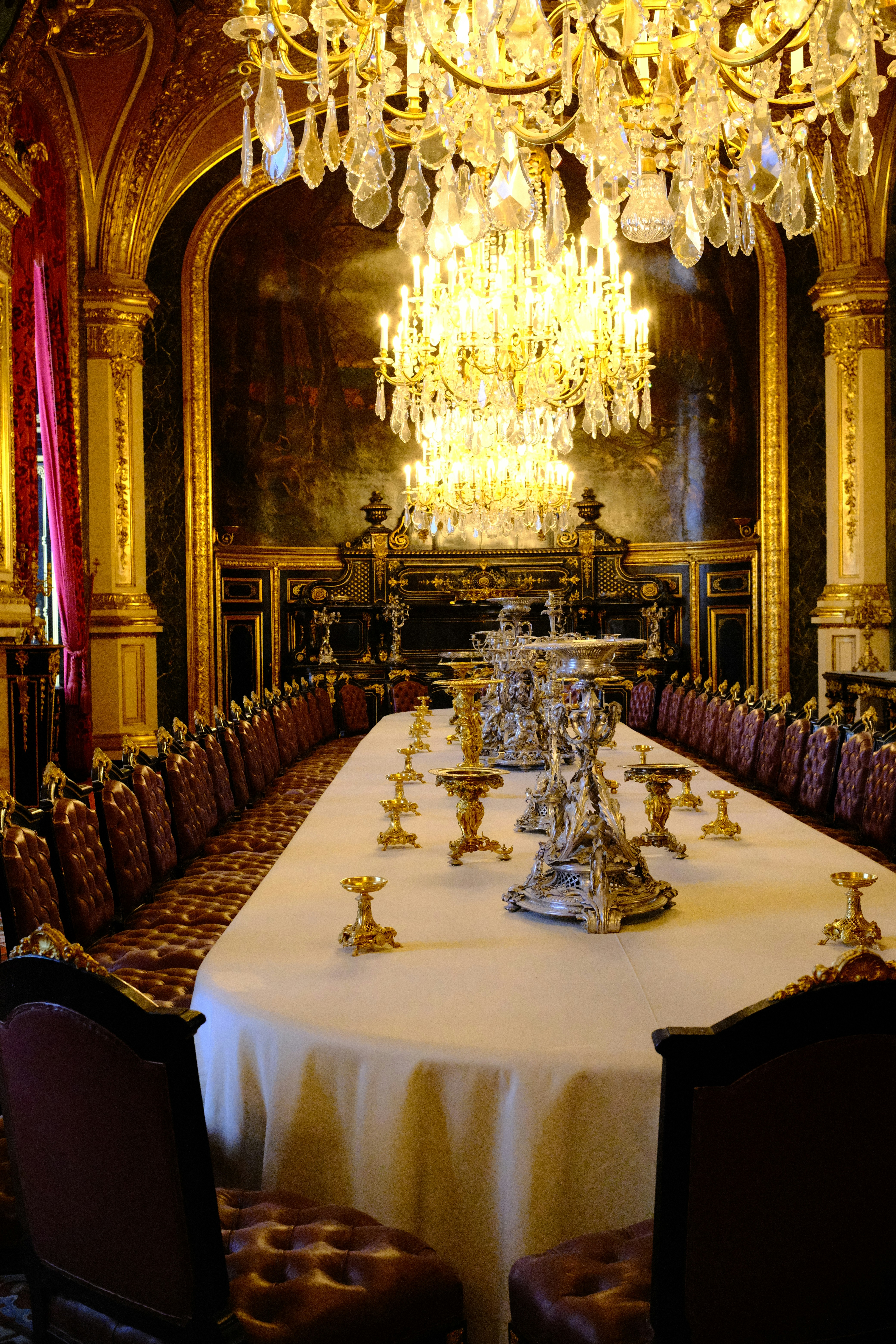 Crystal chandelier over a grand gilded banquet hall