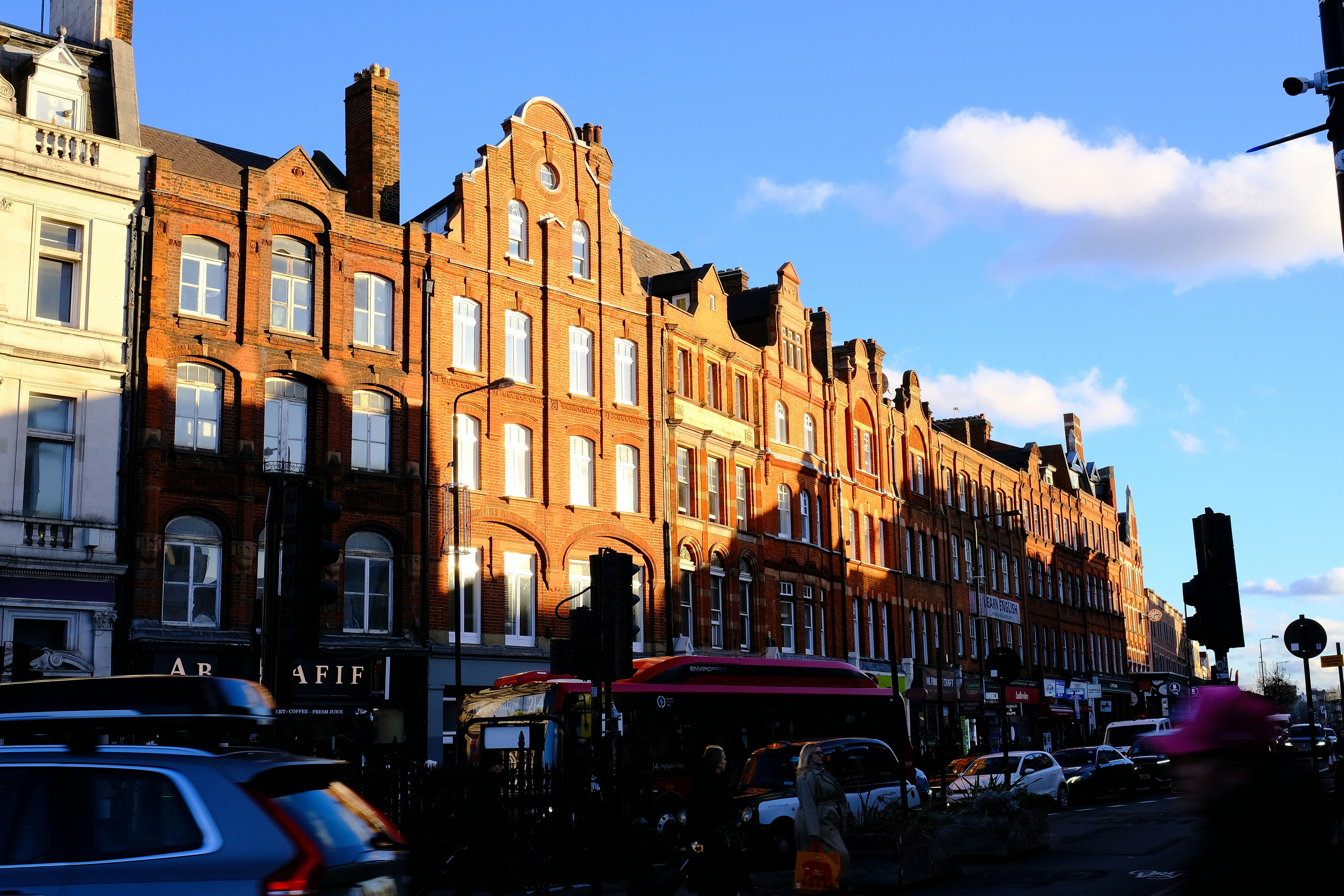 Brick Belle Époque: A Sunlit Row of Townhouses with Bustling Street Life