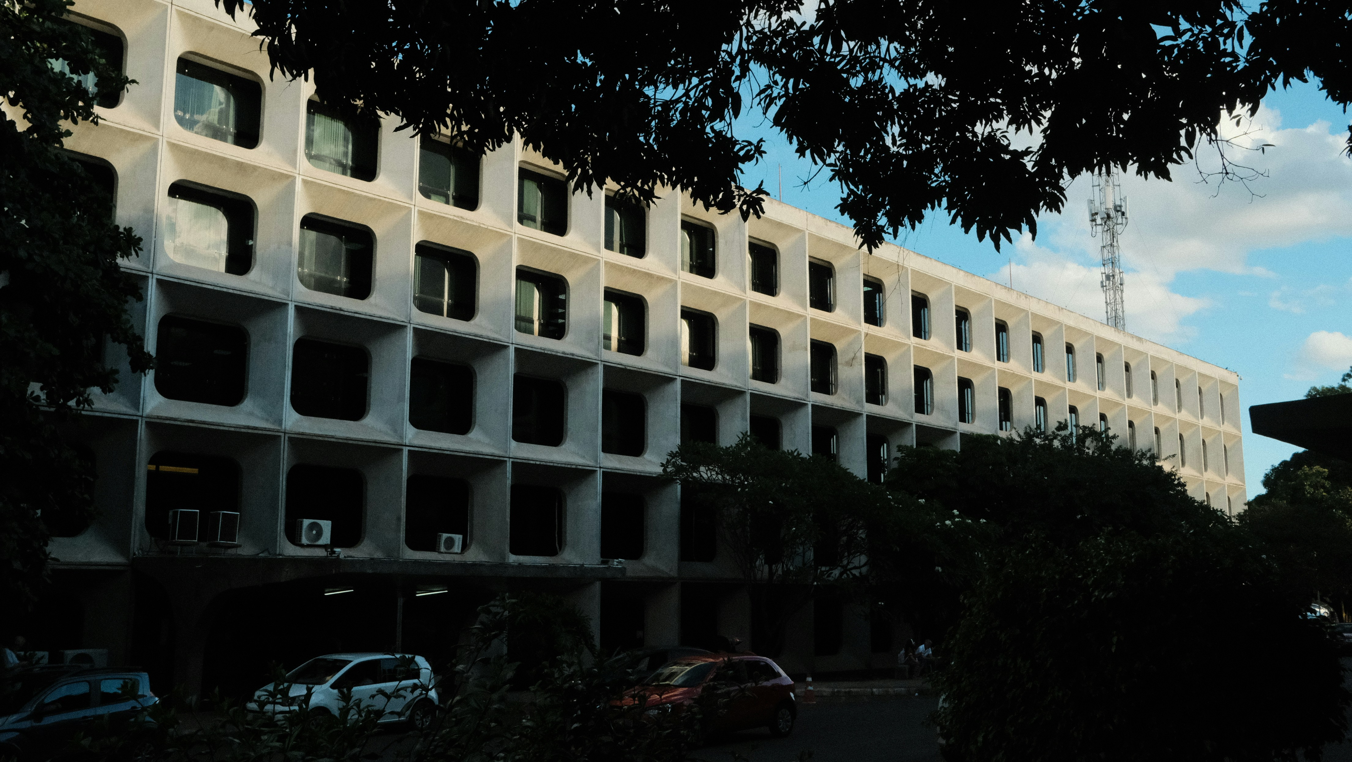 Brutalist Courtyard: Light and Shadow Across a Blocky Facade
