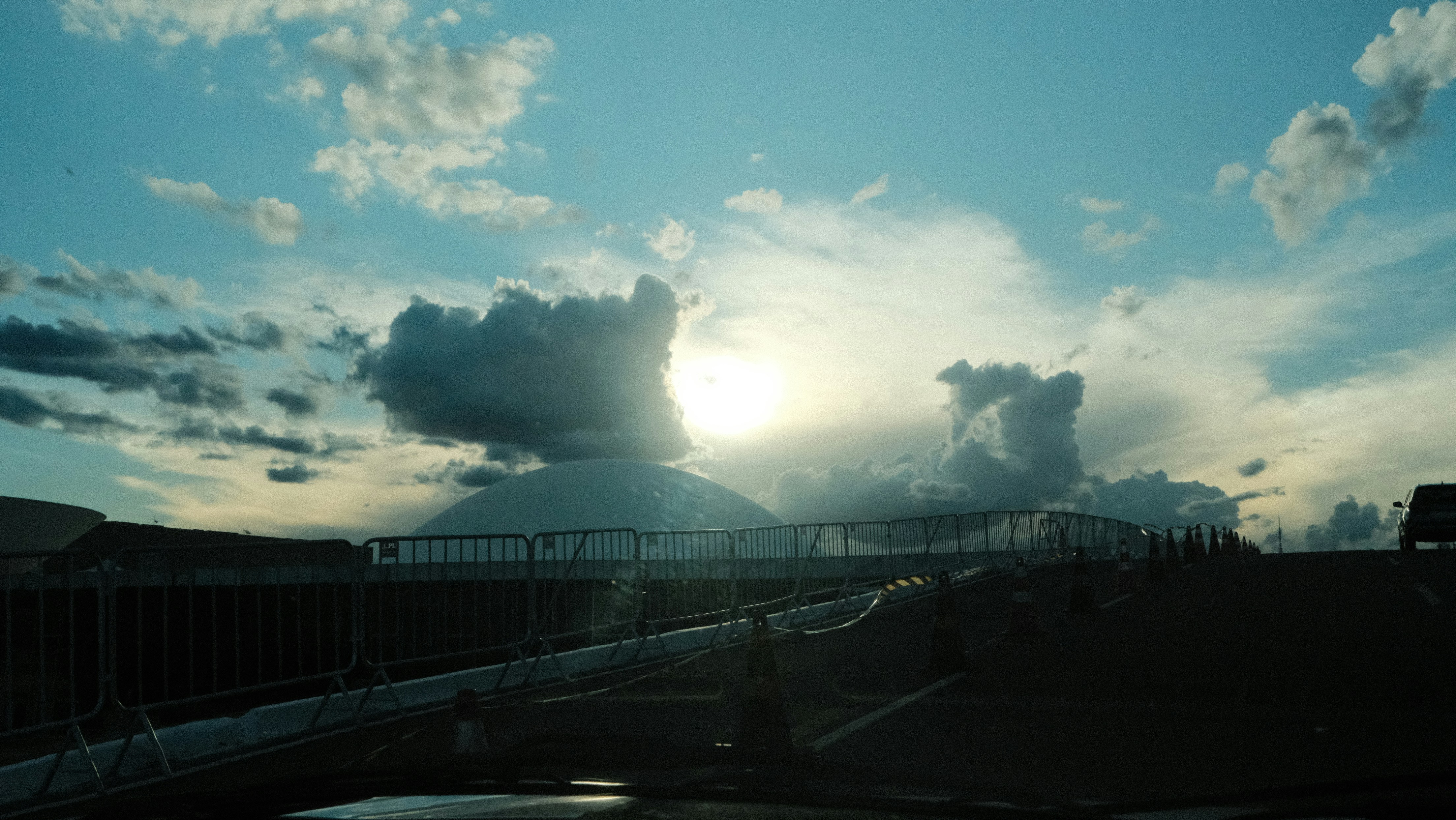 Sunlit Sky Over a Quiet Rooftop Road