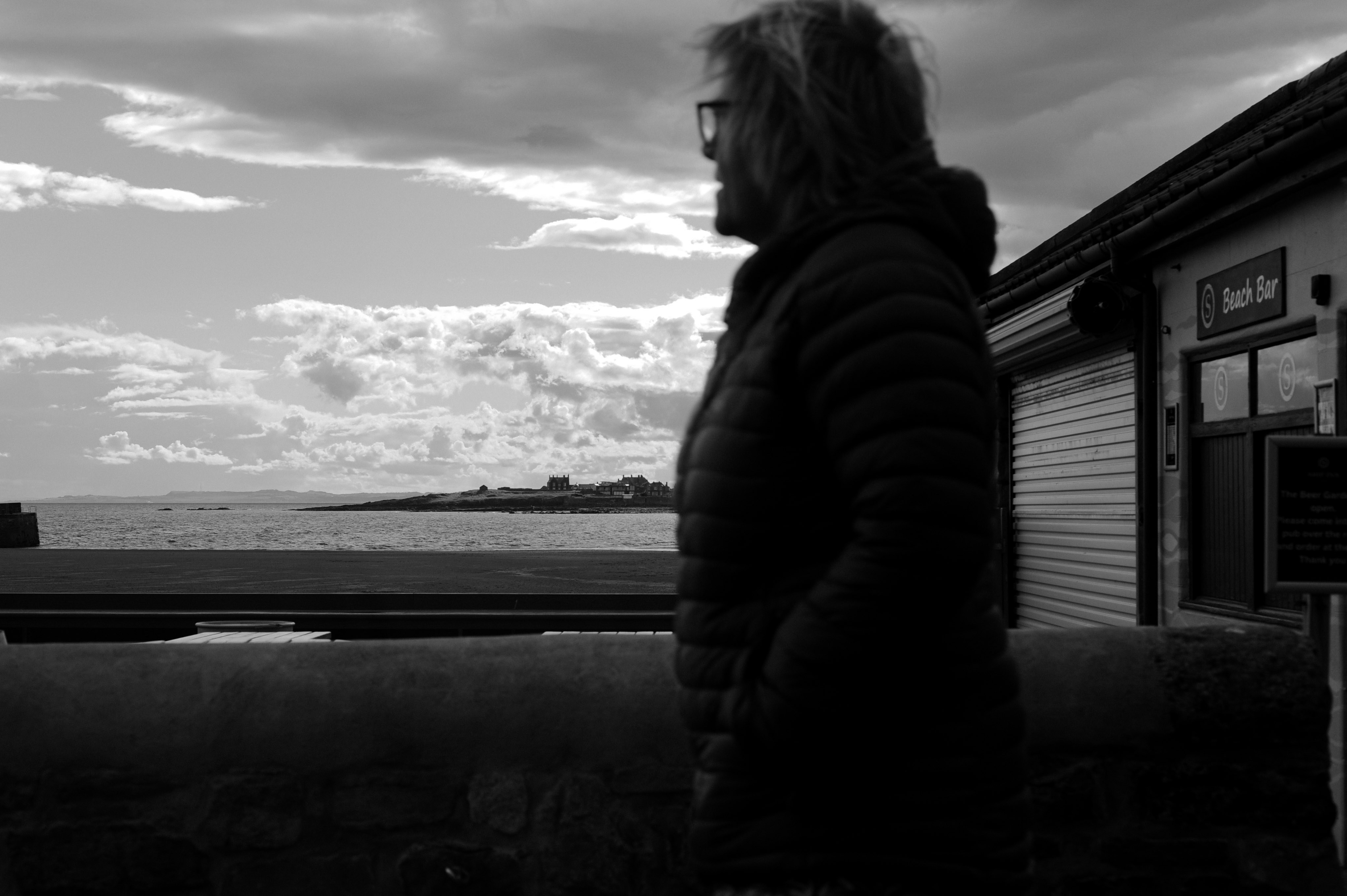 Distant Sea Breeze: A Quiet Portrait by the Pier