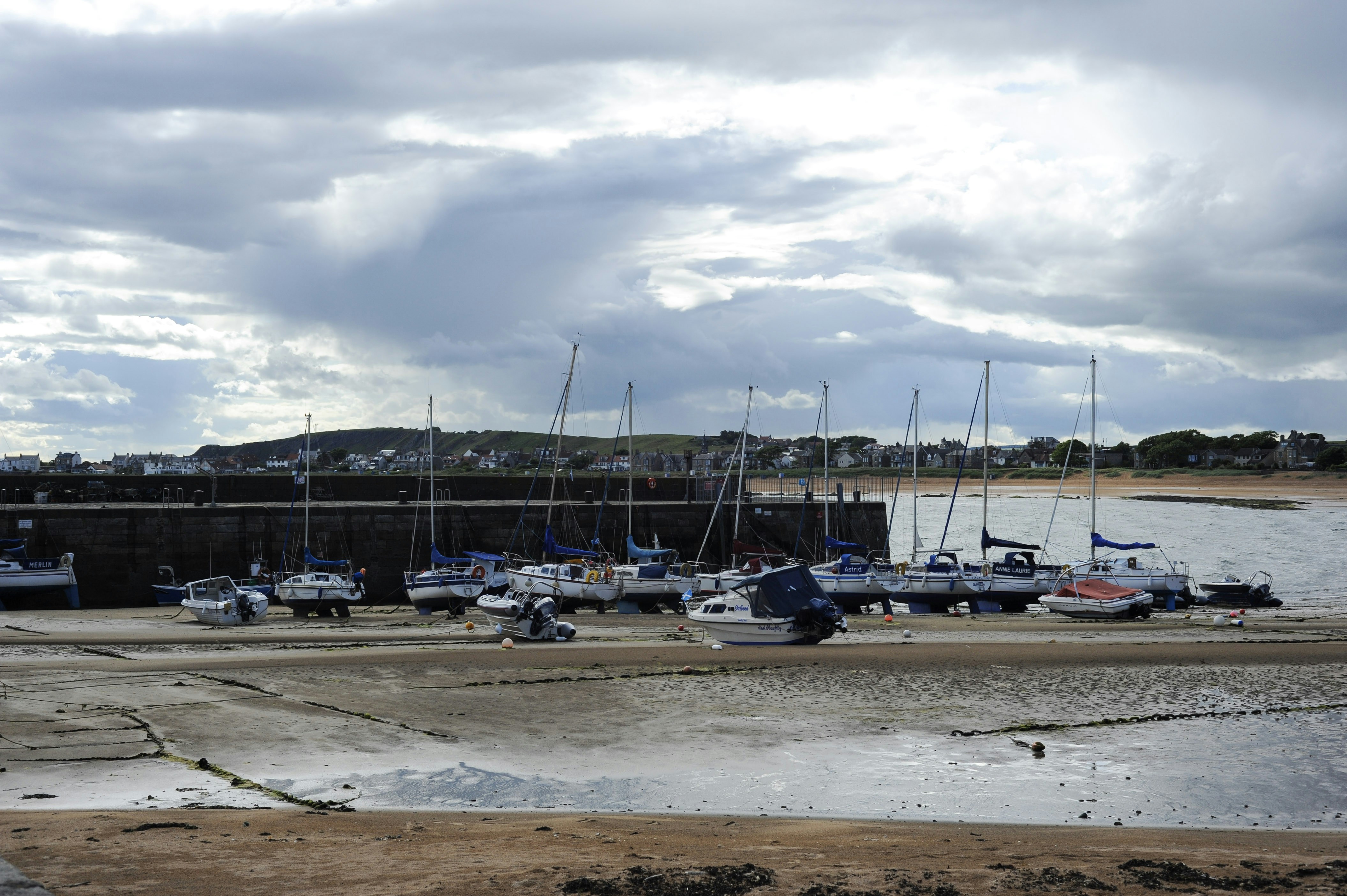 Marina Quiet: Boats Rest Along a Brayton Cove Under Clouded Sky