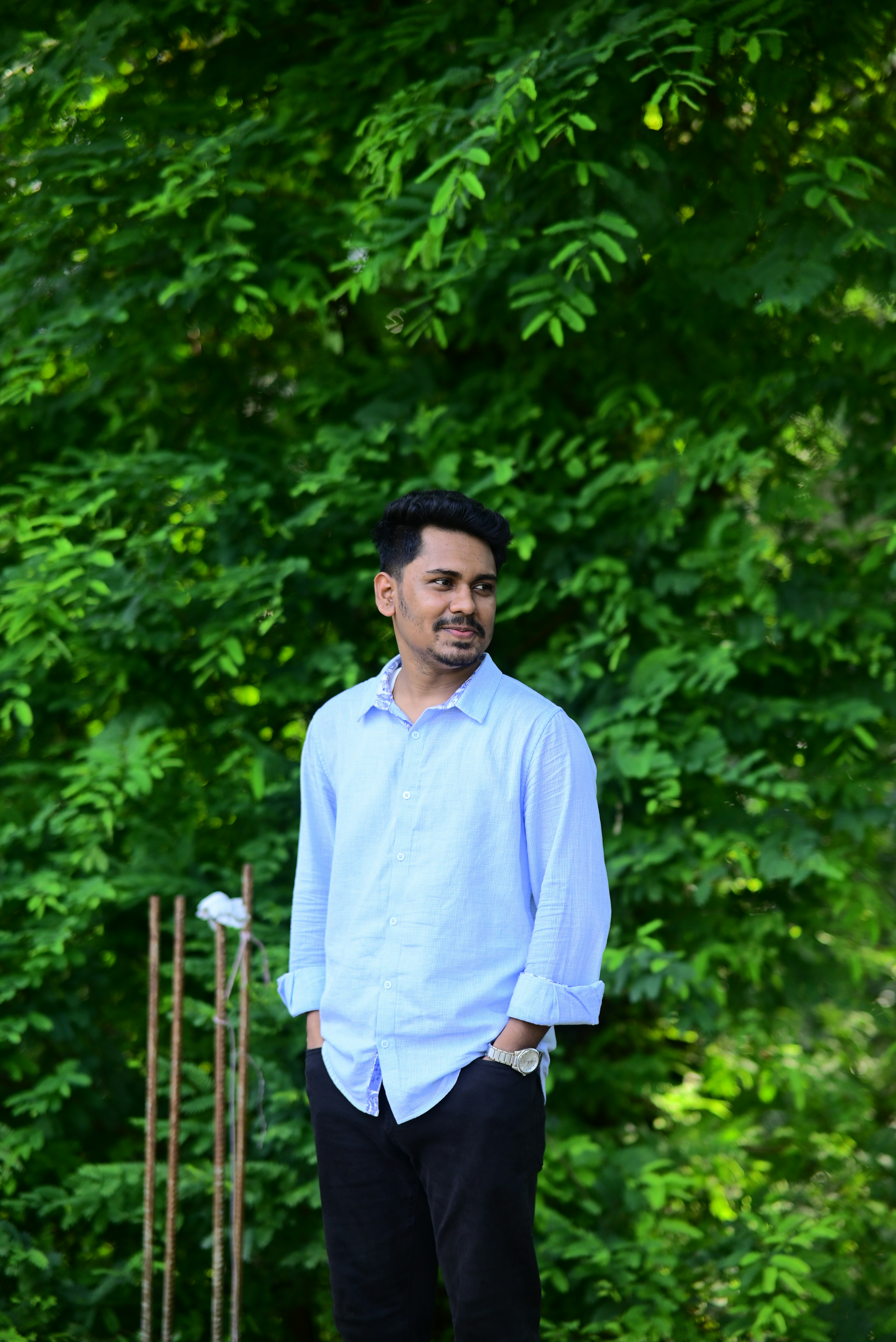 Soft-Blue Shirt, Green Canopy: A Quiet Portrait in Nature