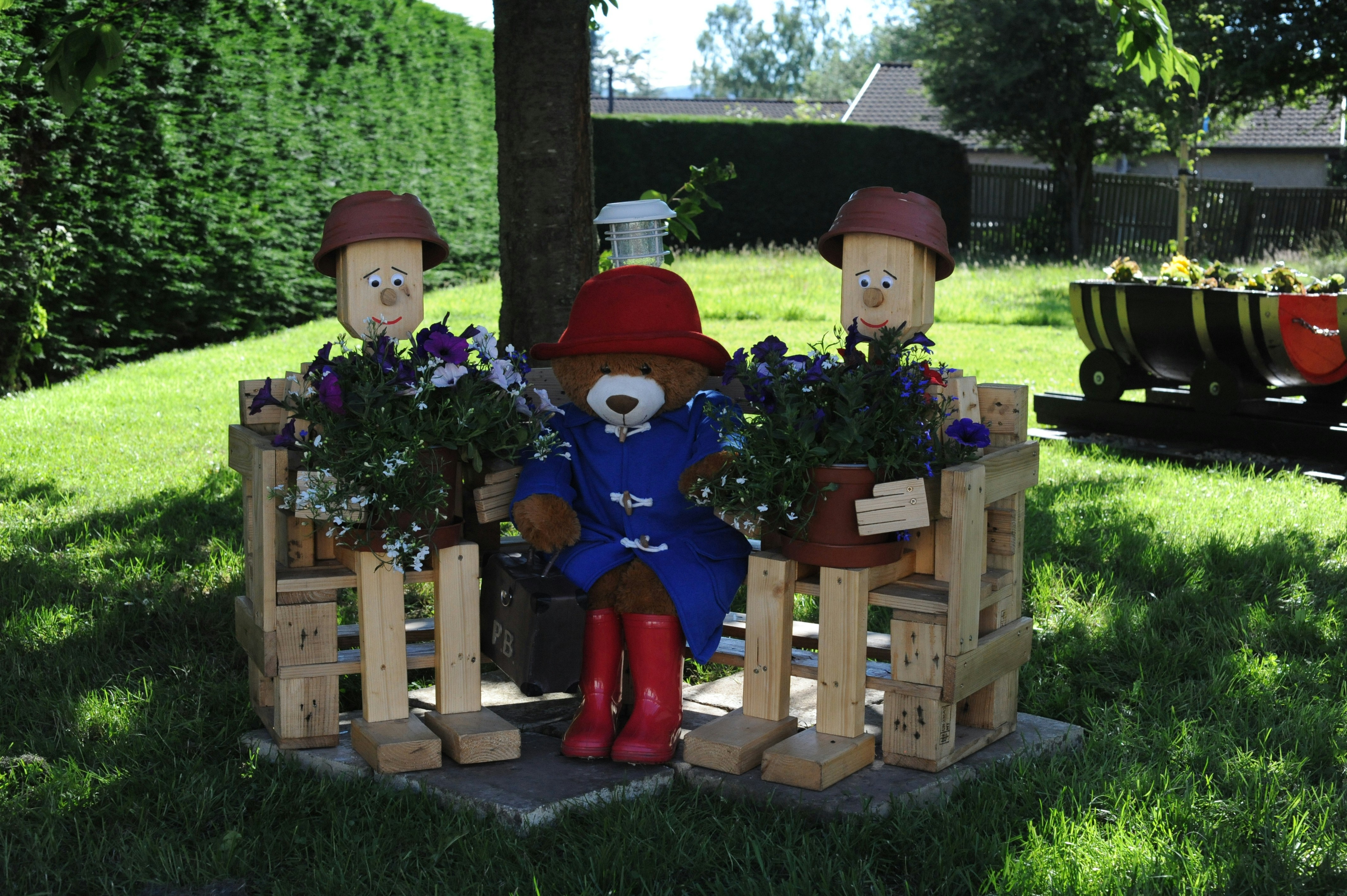 Three-Warden Statues in a Sunlit Garden