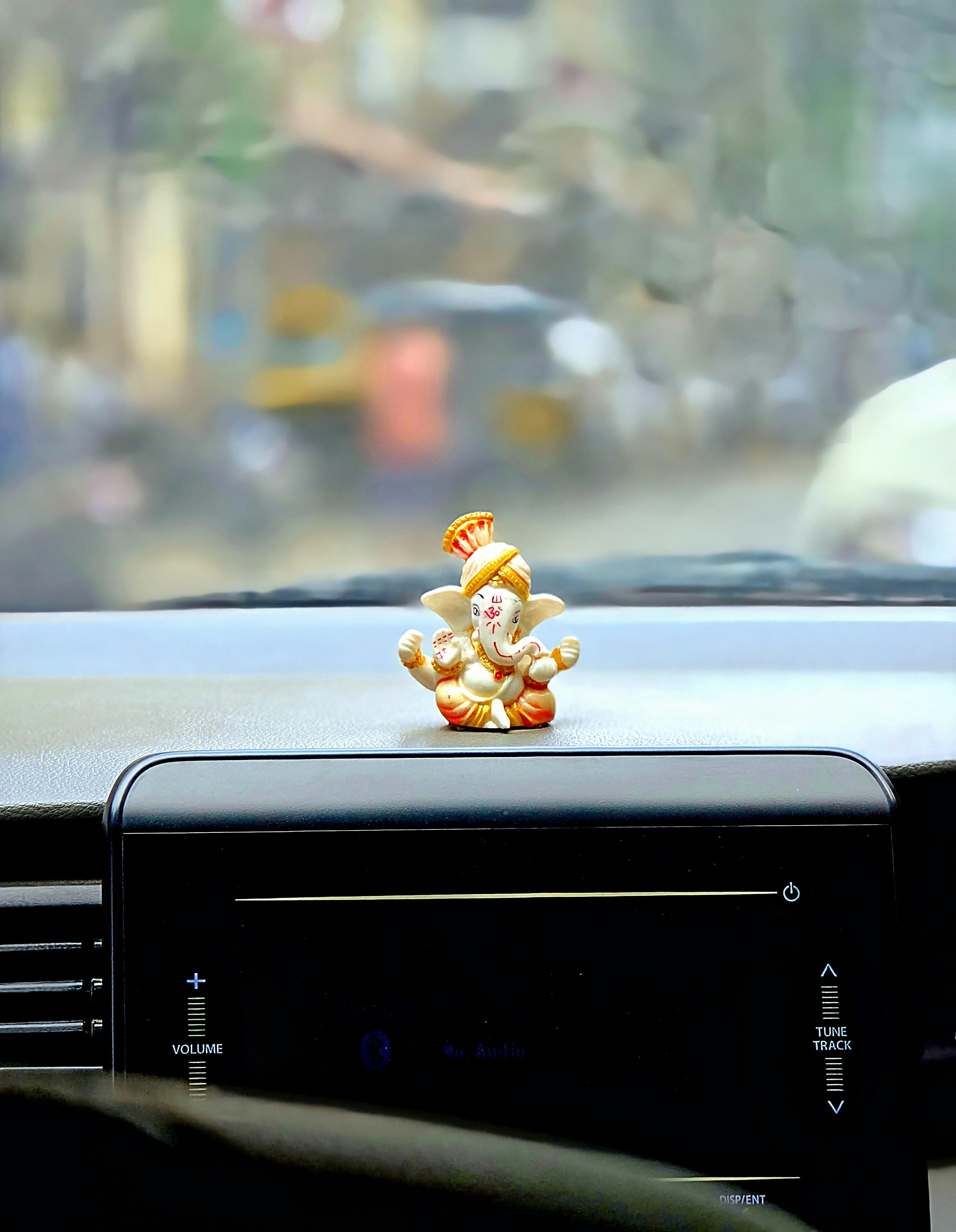 Tiny Ganesh on the Dash: A Sacred Figurine Anchors the Car’s Center Console