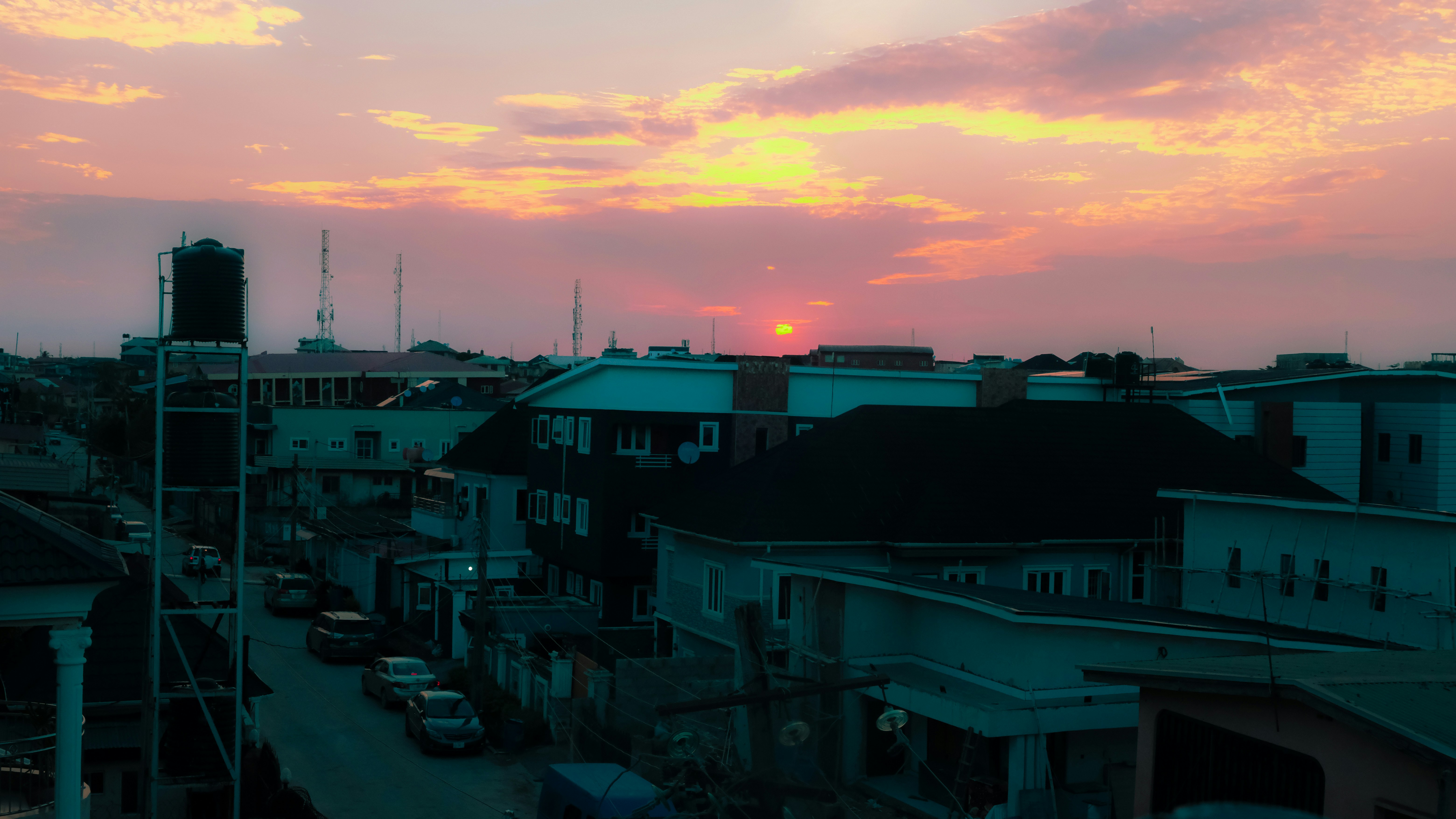 Sunset over a quiet urban street: silhouettes and warm glow