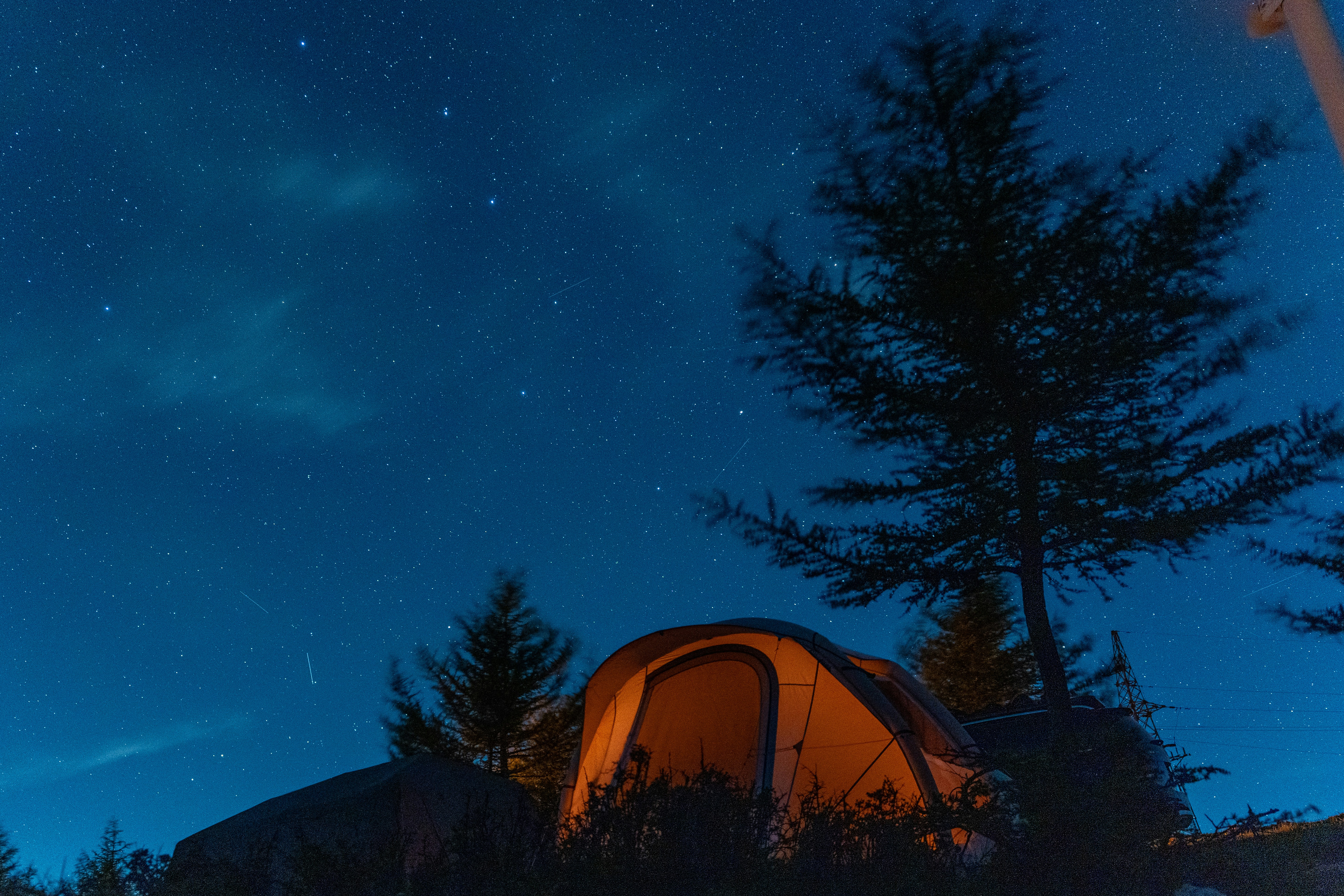 Starlit Campsite under a Cone of Light