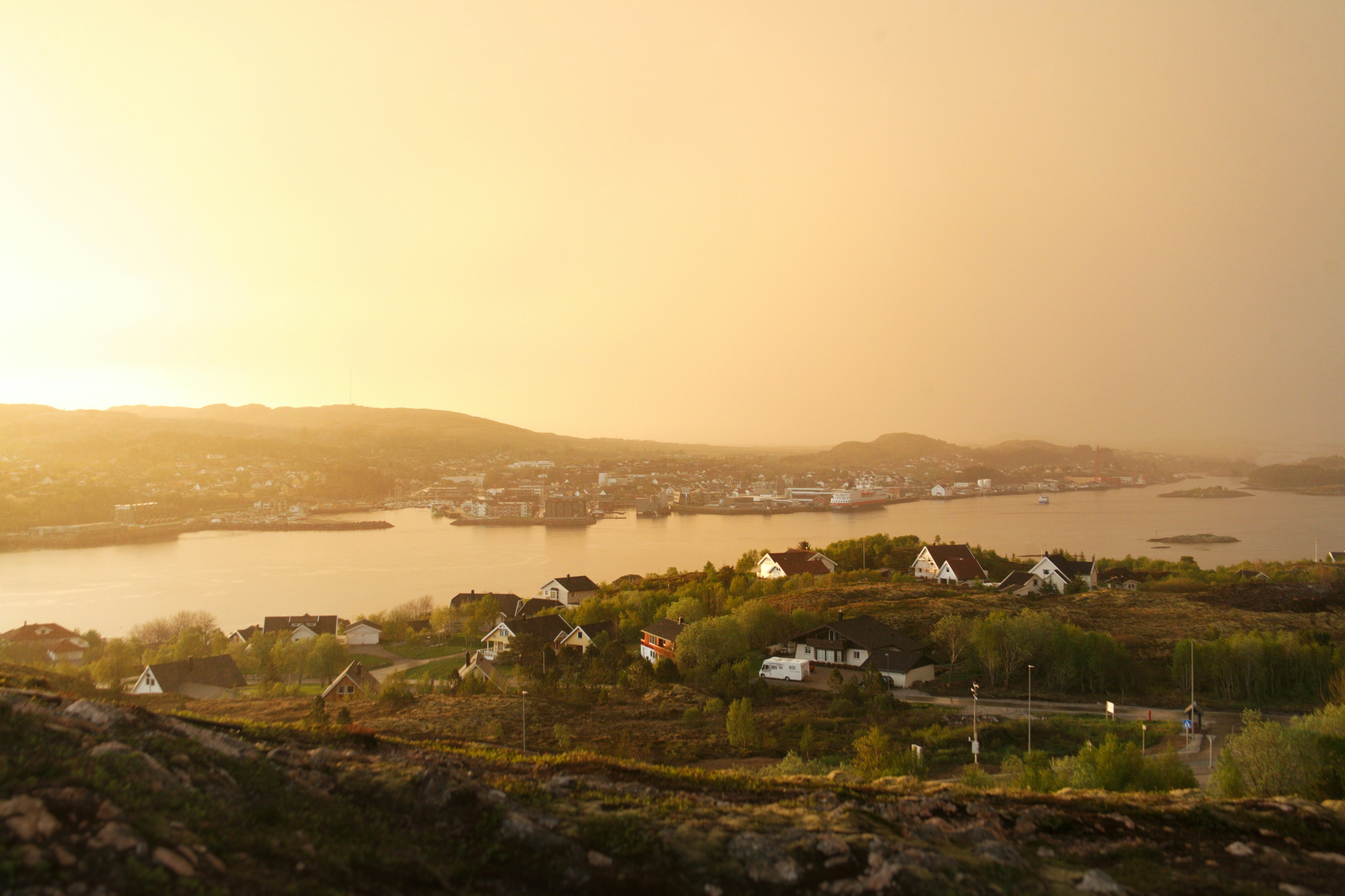Sunlit Coastal Village from a Quiet Ridge