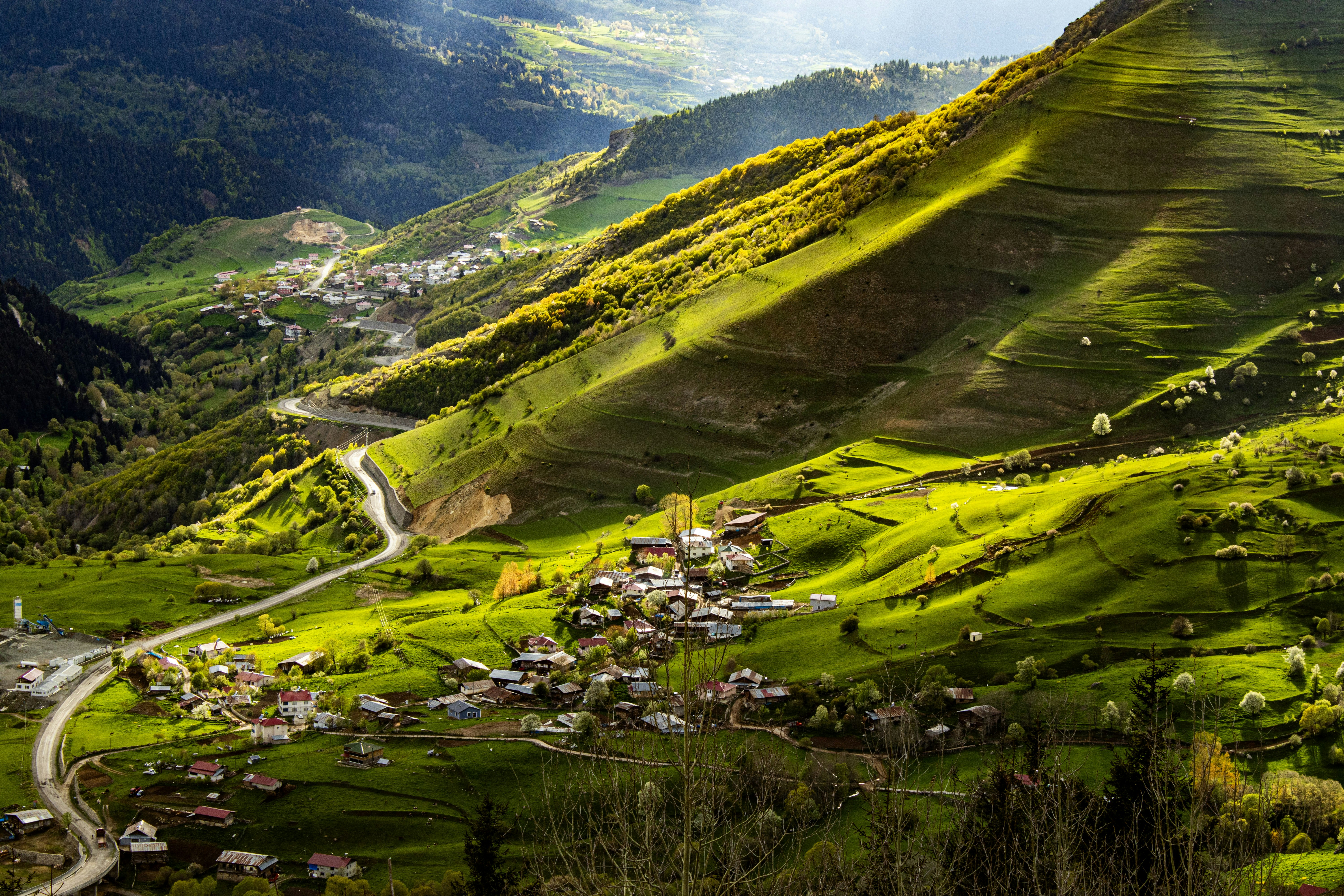 Terraced Highlands: Sunlit Village Carved into Verdant Hills