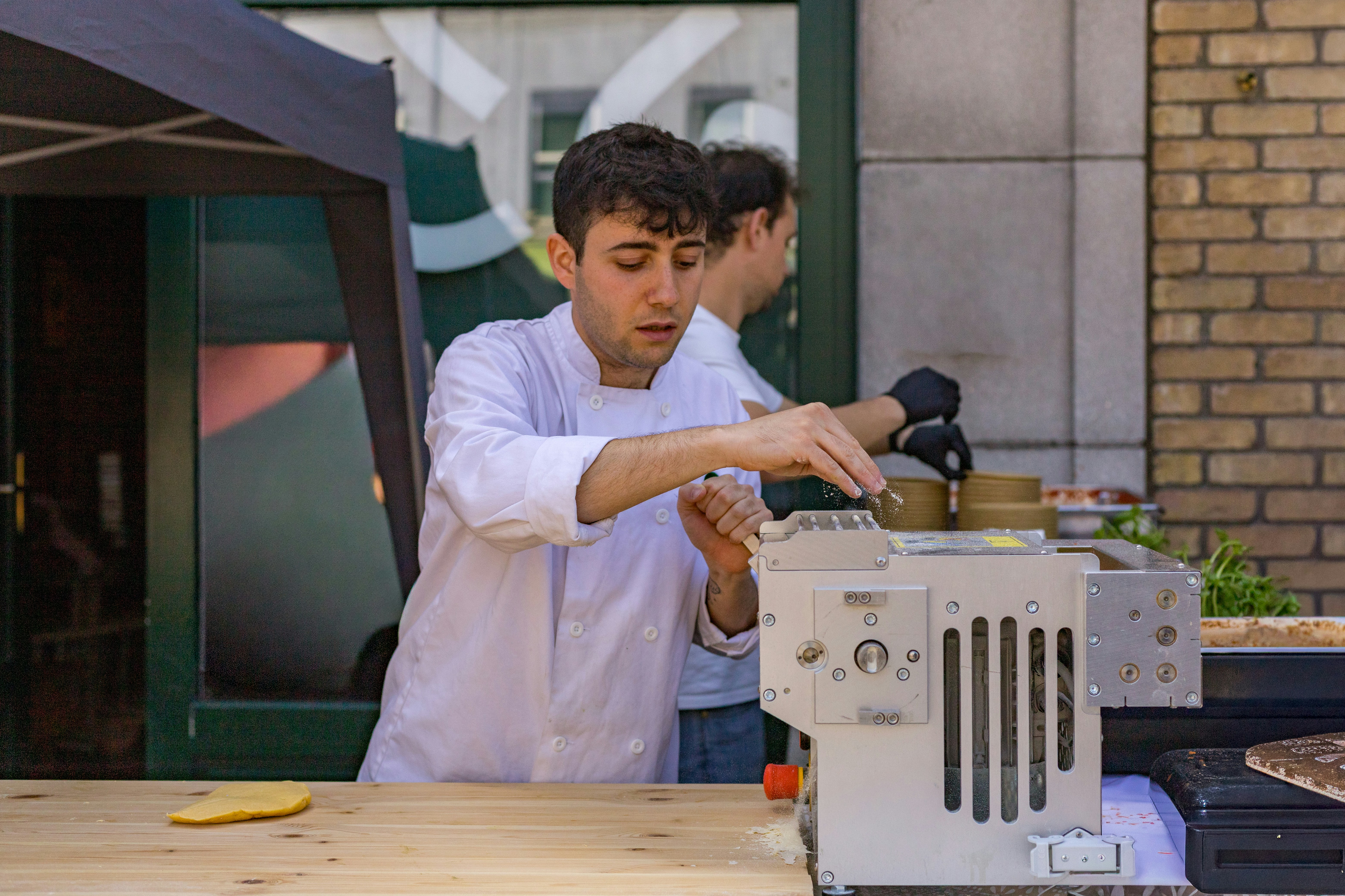 Handmade Precision: A Chef at Work with a Vintage Food Slicer