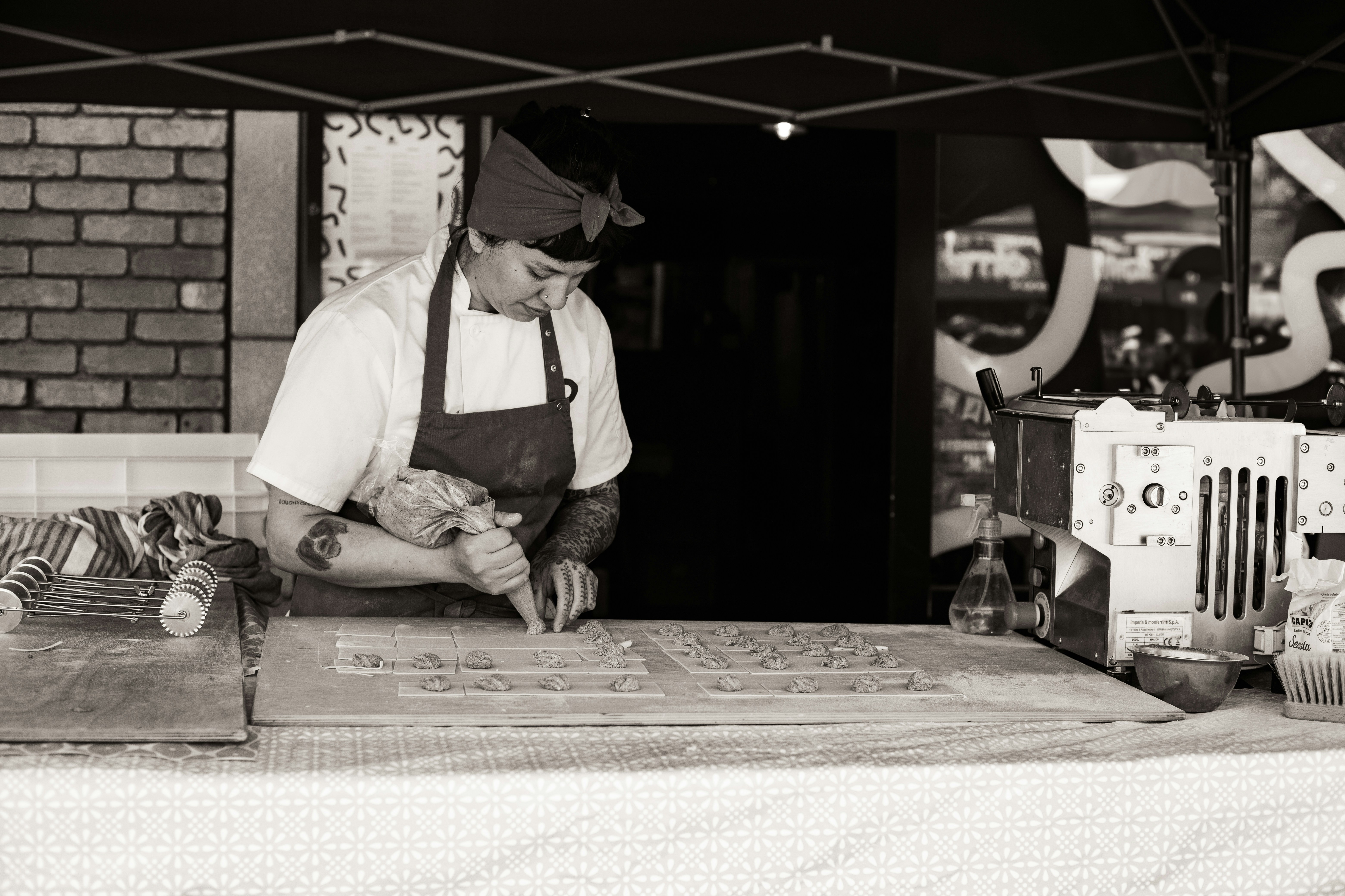 Chiaroscuro in the Kitchen: Hands at Work Under a Street Cart