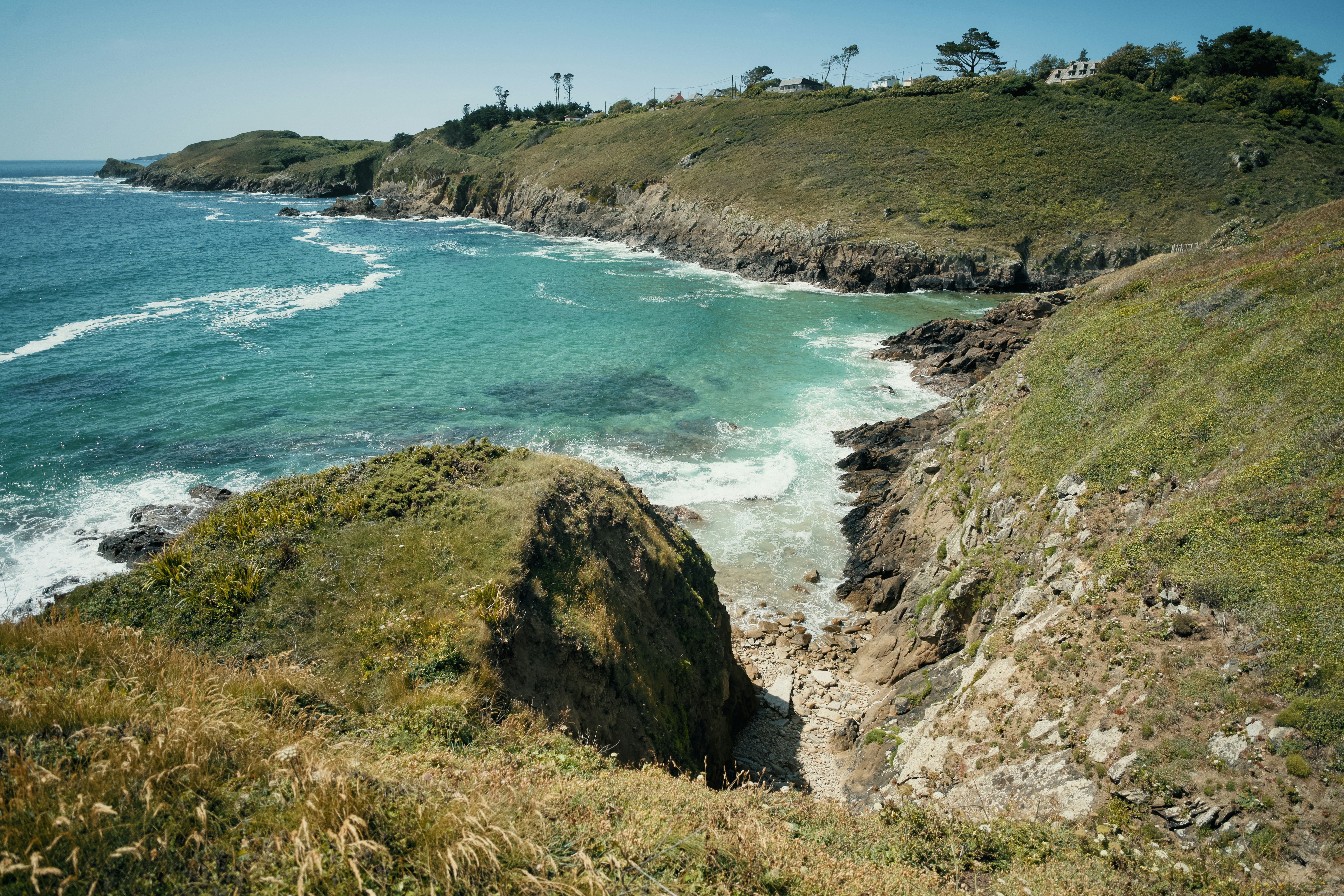 Craggy Coastal Promontory Silhouetted by Turquoise Waves