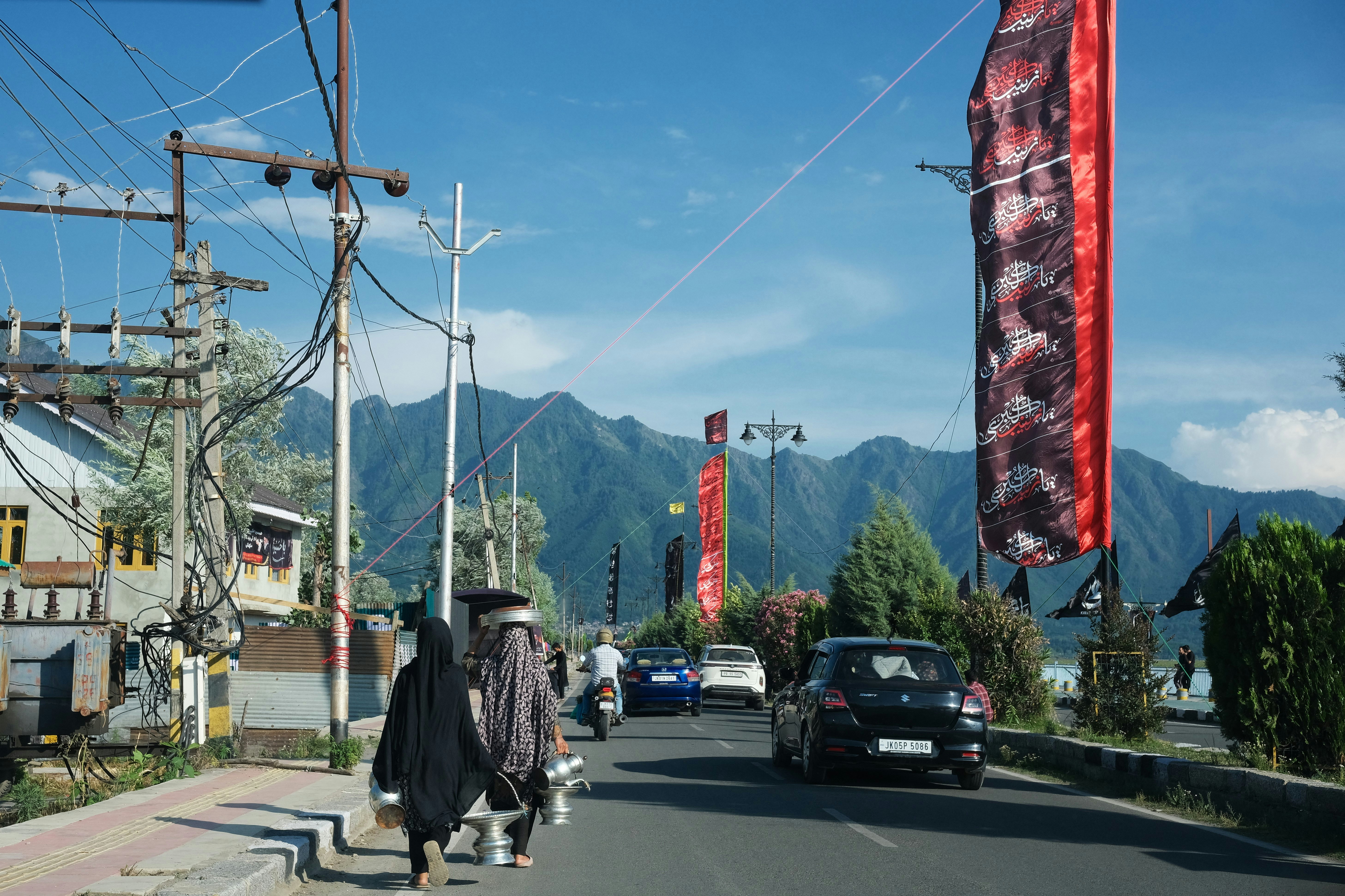 Pedestrian Parade Under Scenic Mountain Banner