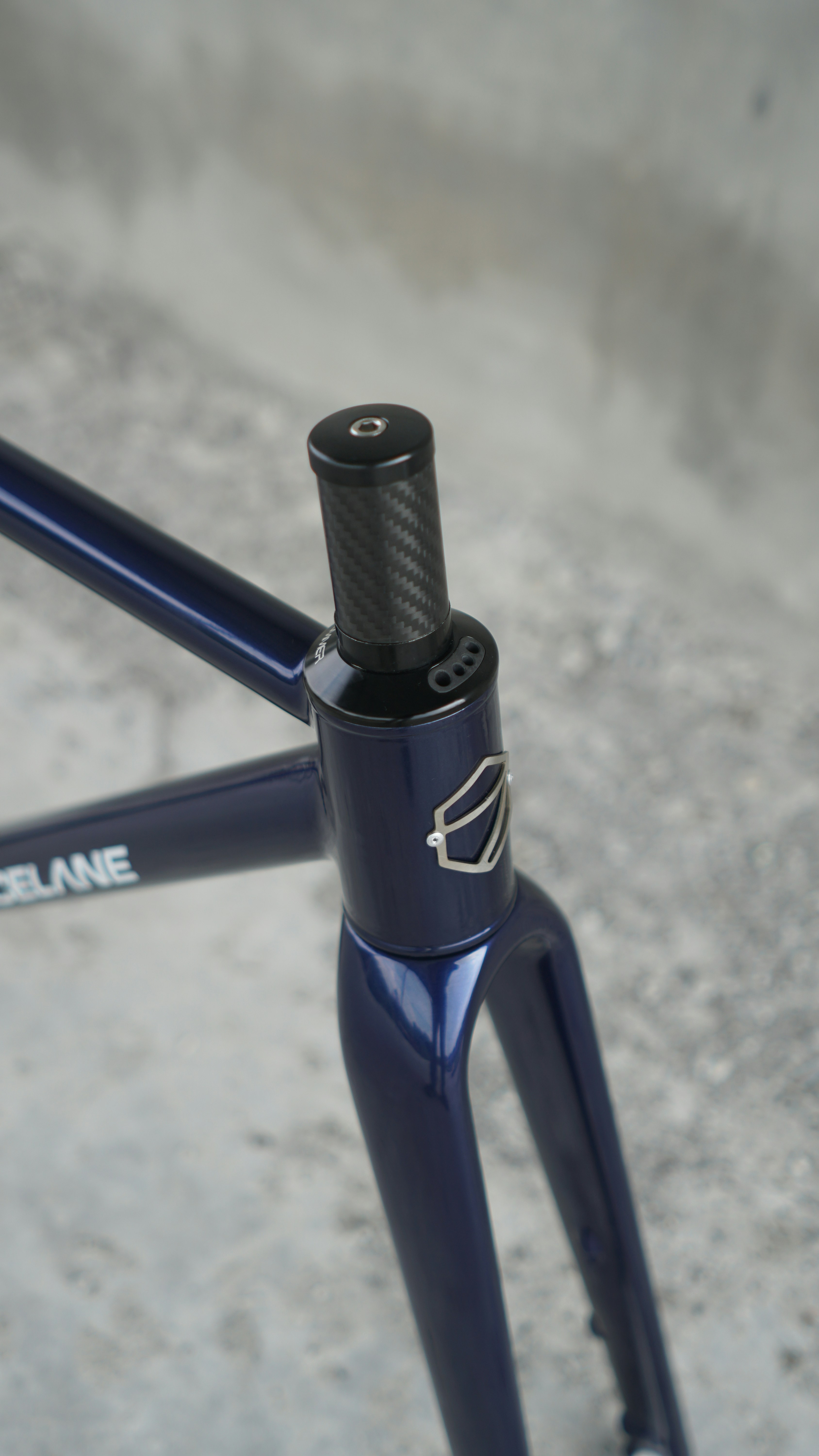 Carbon-stemmed focus: close-up on a glossy blue bicycle frame