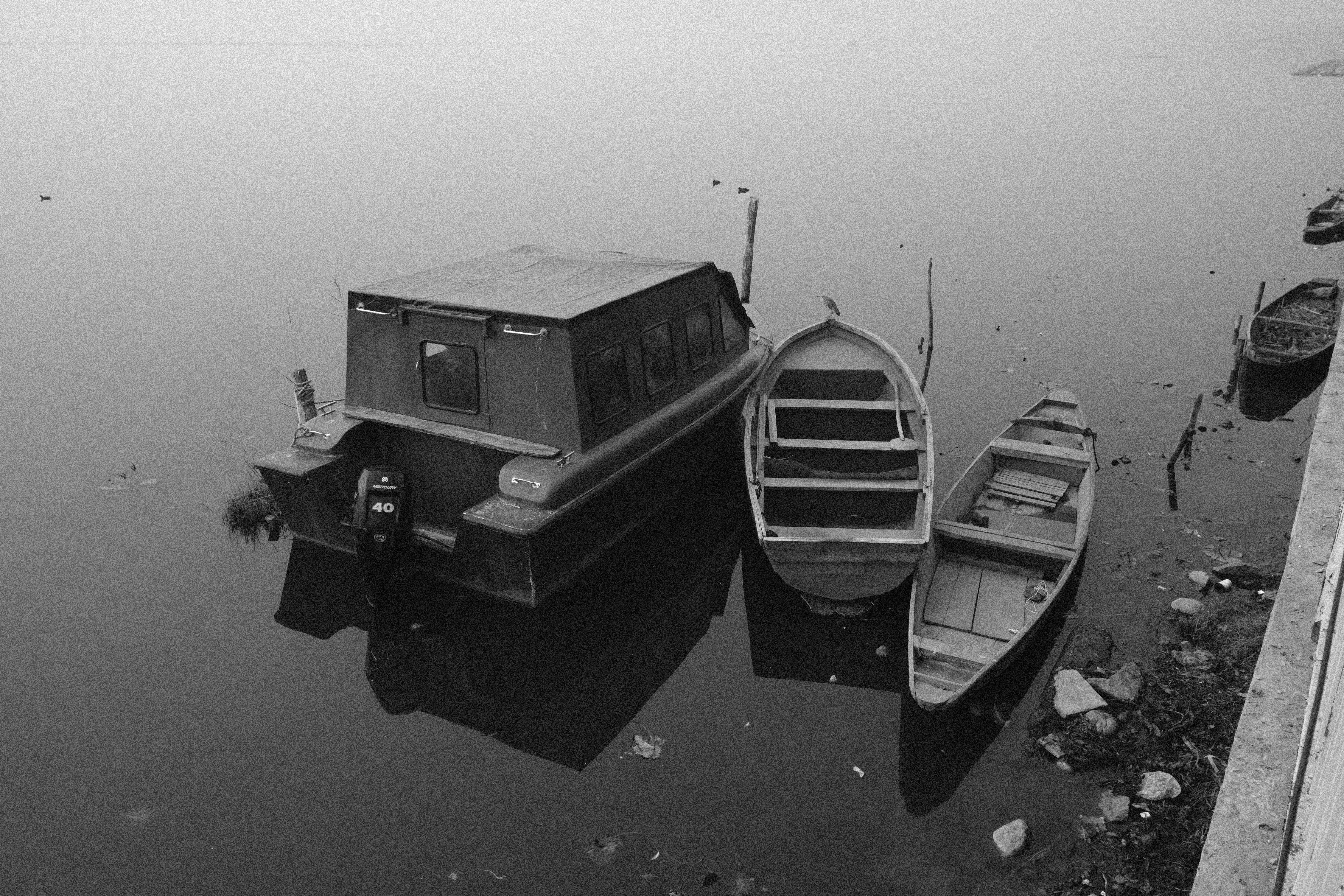 Docked in Monochrome: A Quiet Squadron of Boats by the Riverside