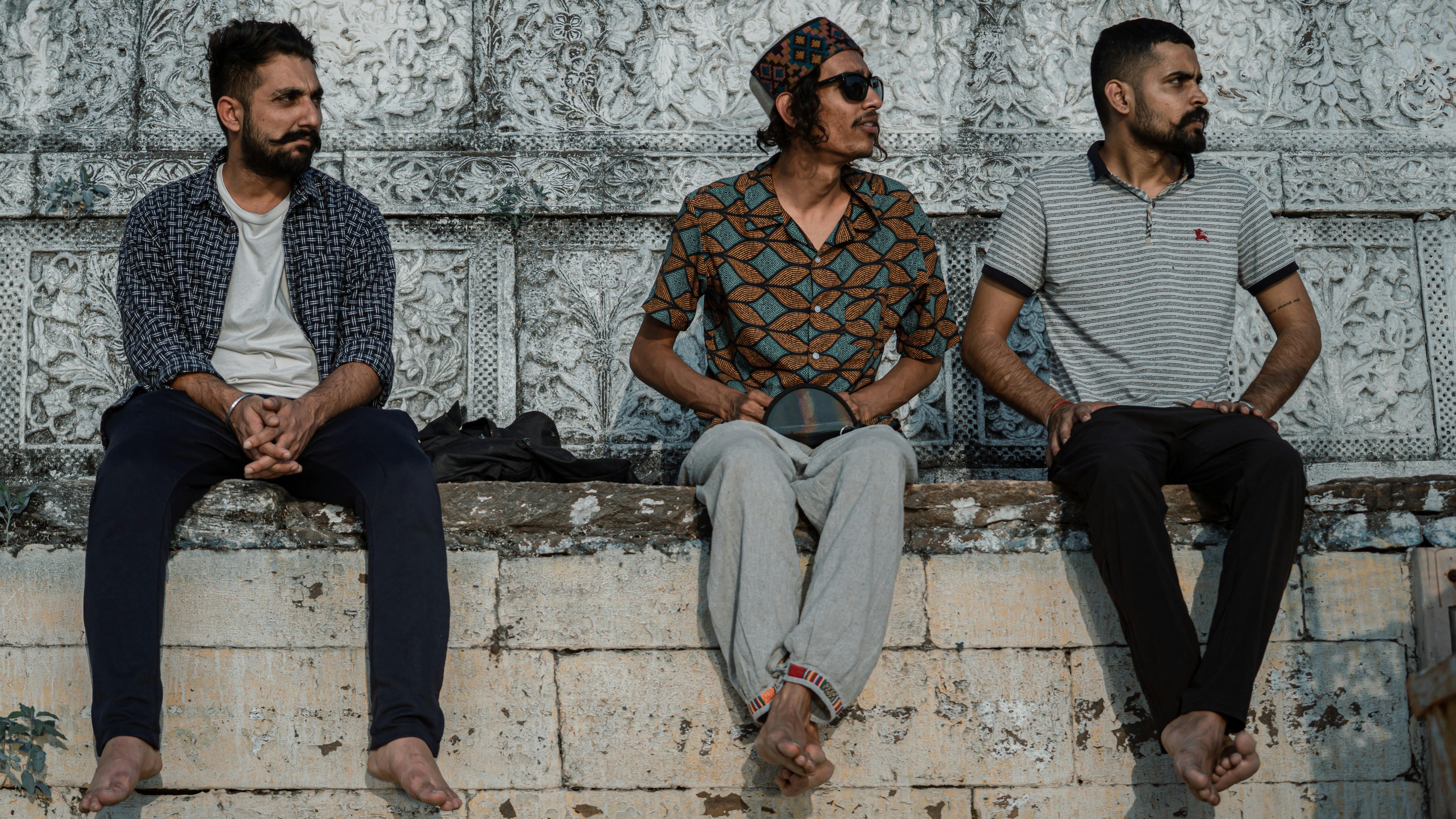 Three Distant Moments: A Row of Men on a Stone Terrace