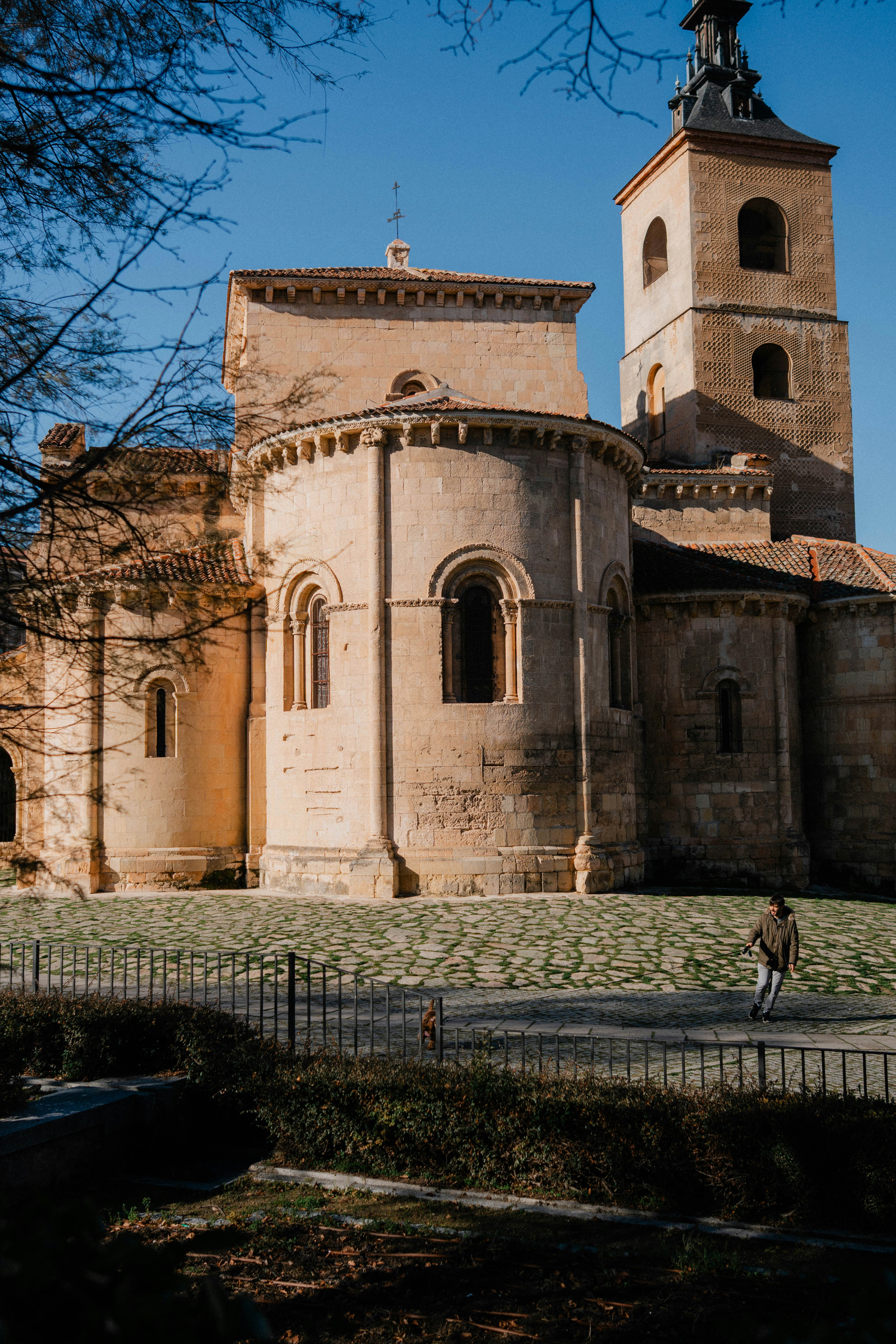 Sunlit Romanesque Church Facade Under a Clear Blue Sky